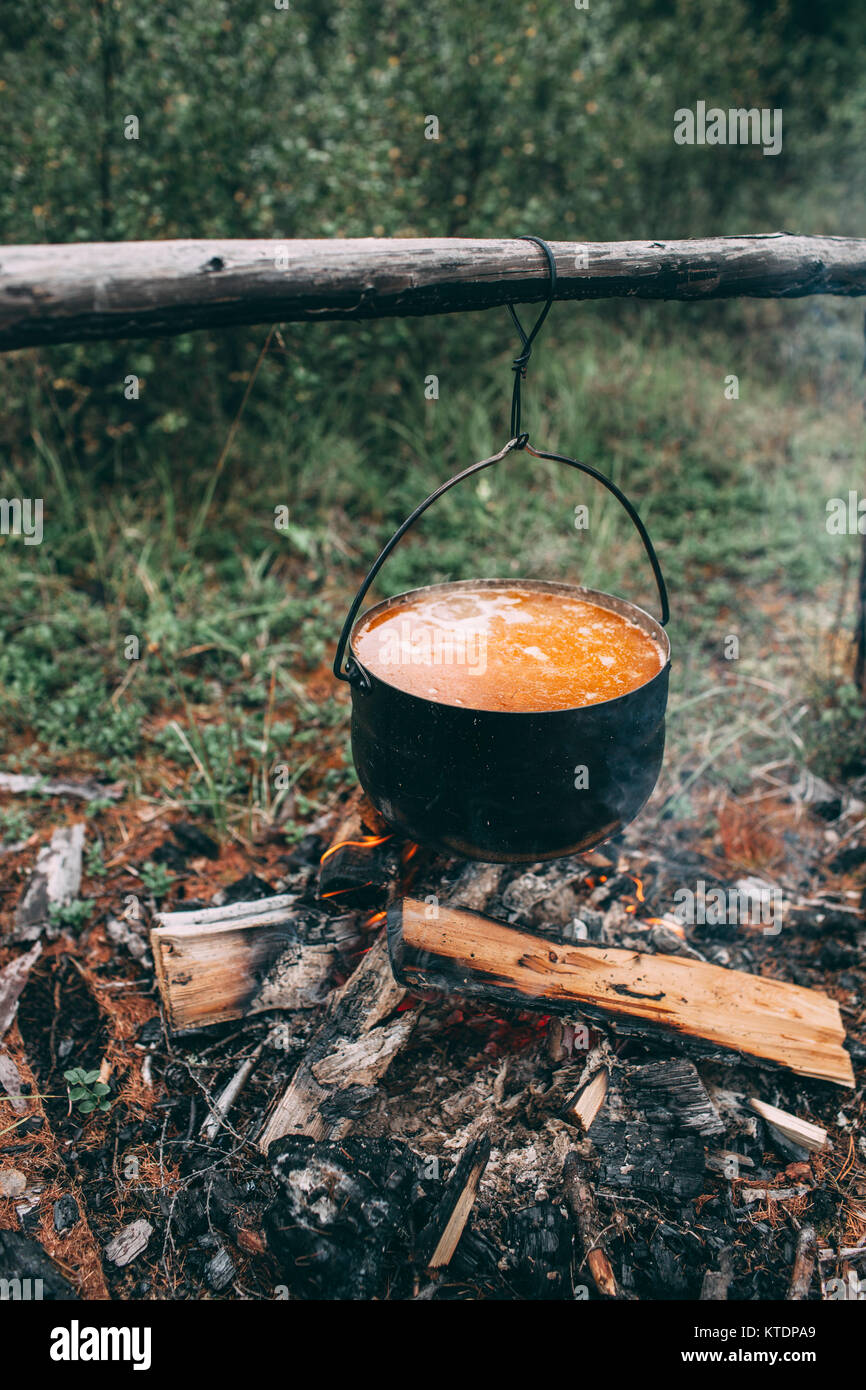 Cauldron over camp fire Stock Photo - Alamy