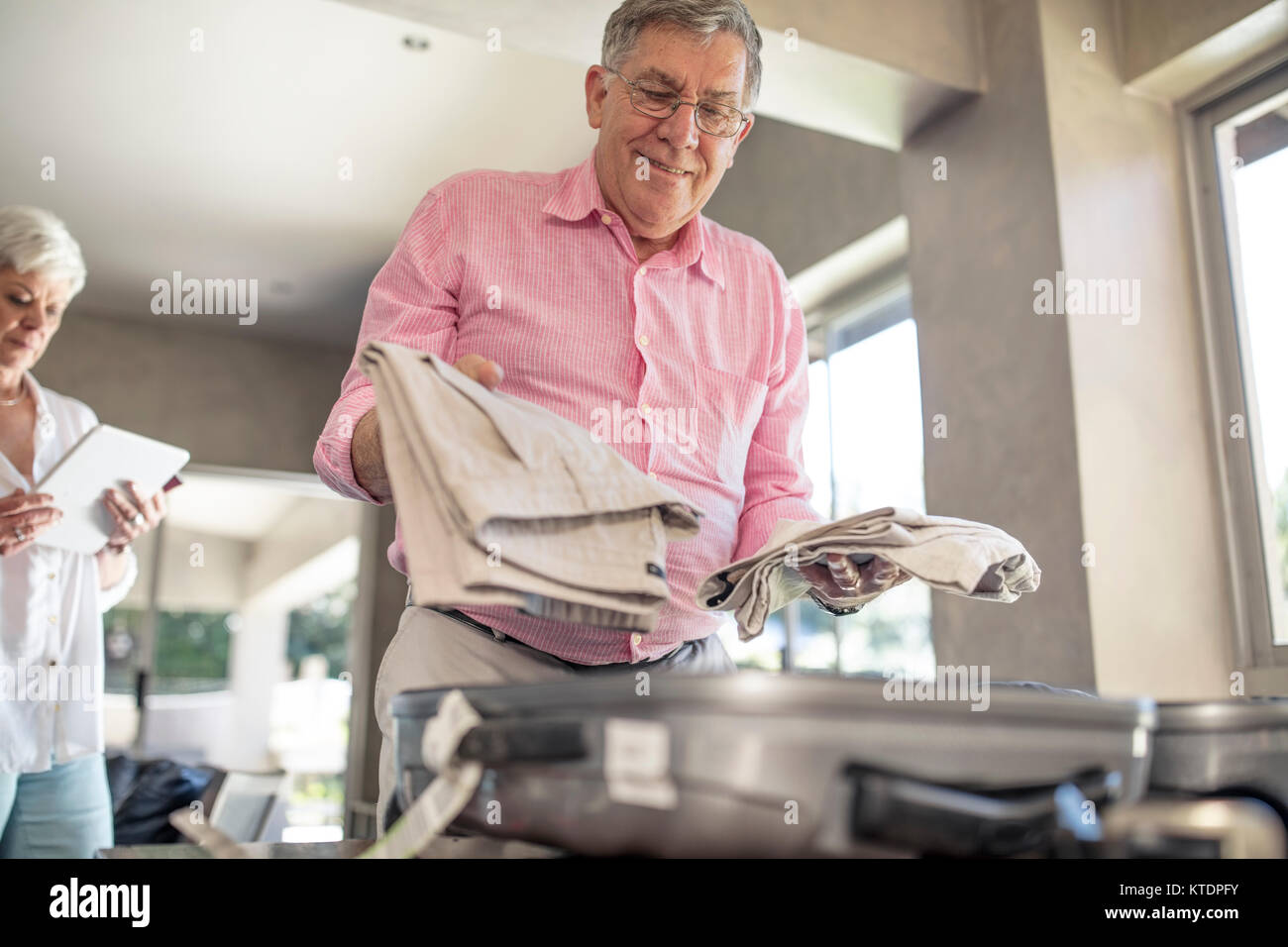 Senior man packing for a trip Stock Photo - Alamy