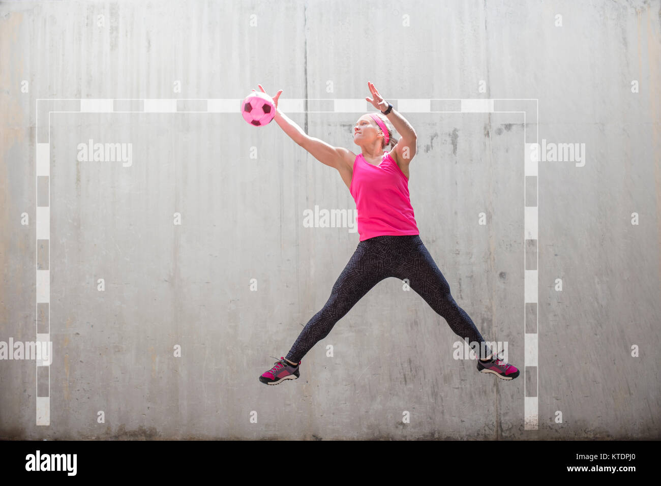 Woman jumping to catch a ball Stock Photo - Alamy
