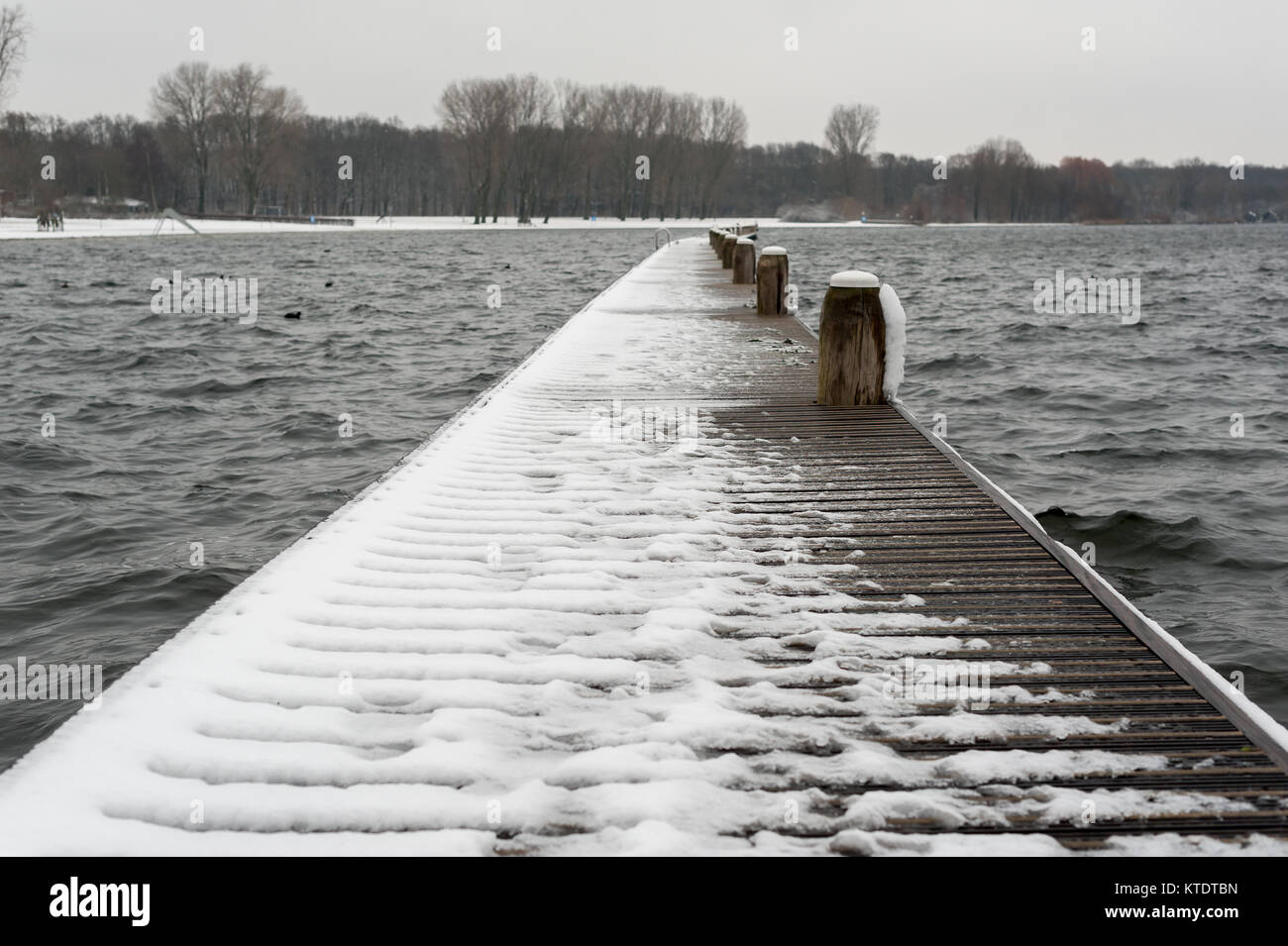 Floating wooden bridge on a lake under the snow Stock Photo - Alamy