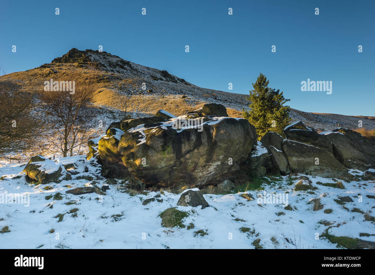 Rocks, trees, snow and blue sky at Binn Green, Greenfield, Saddleworth ...
