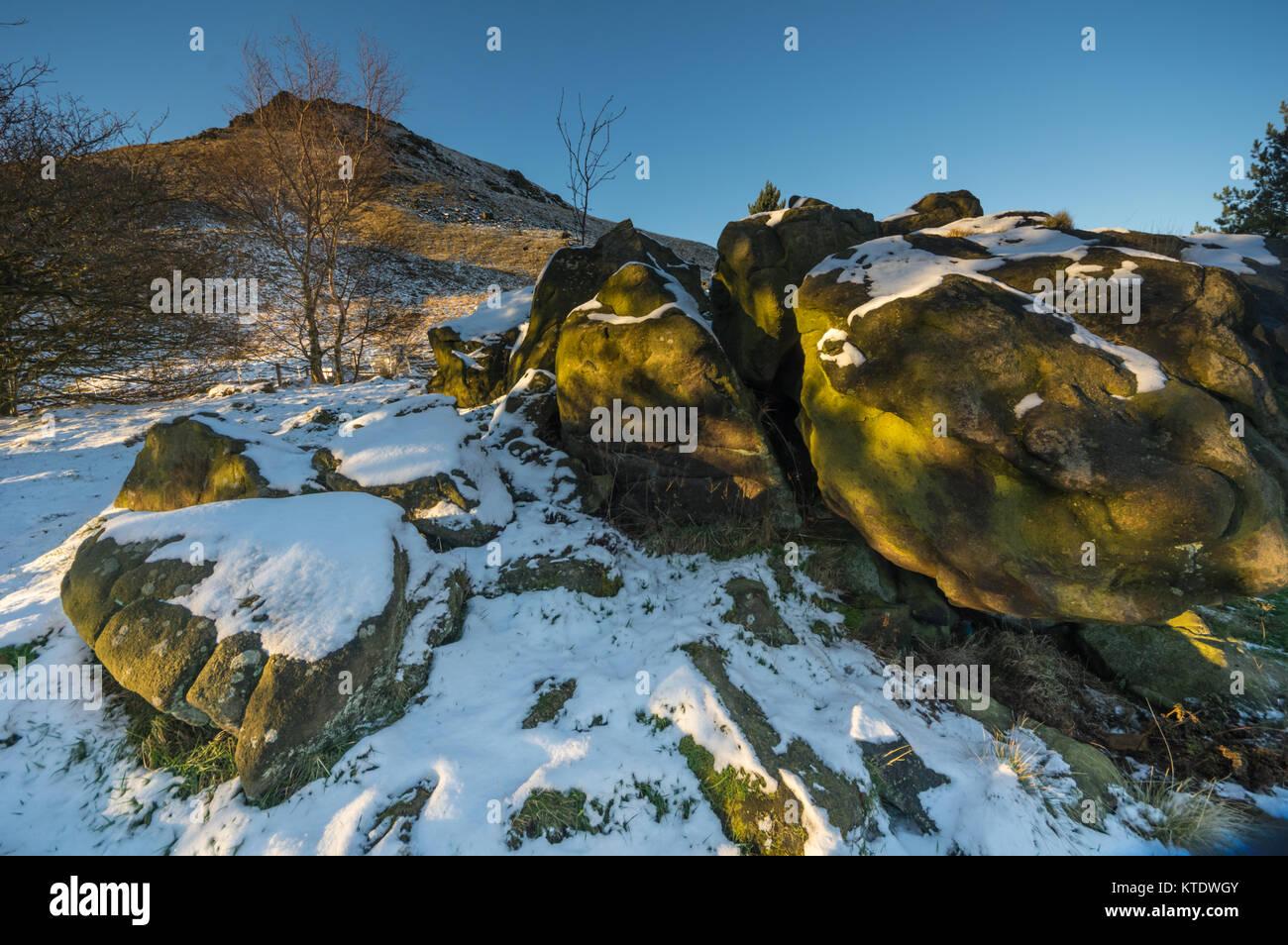 Rocks, trees, snow and blue sky at Binn Green, Greenfield, Saddleworth ...