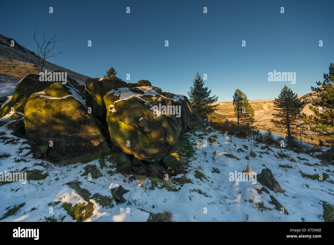 Rocks, trees, snow and blue sky at Binn Green, Greenfield, Saddleworth ...