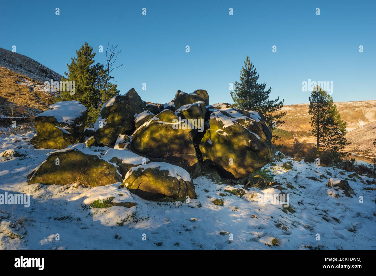 Rocks, trees, snow and blue sky at Binn Green, Greenfield, Saddleworth ...