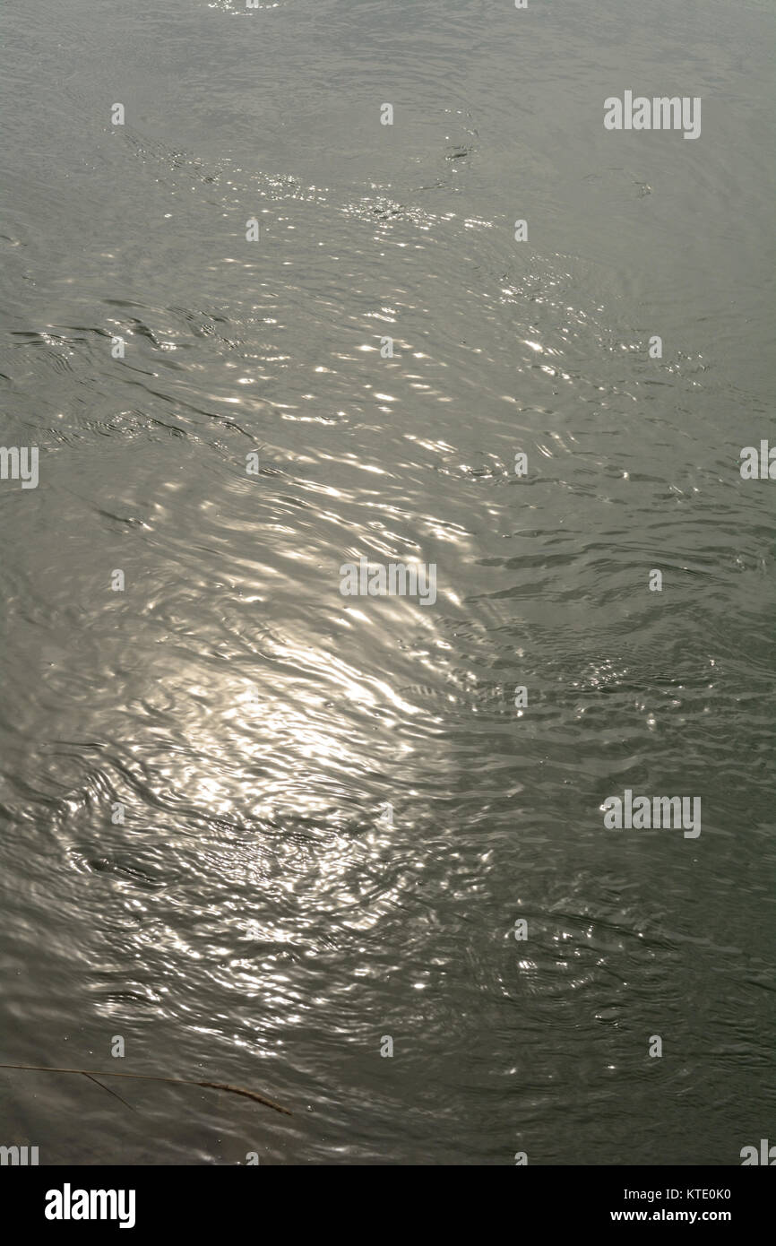 Sun shining on the rippled surface of a river Stock Photo - Alamy