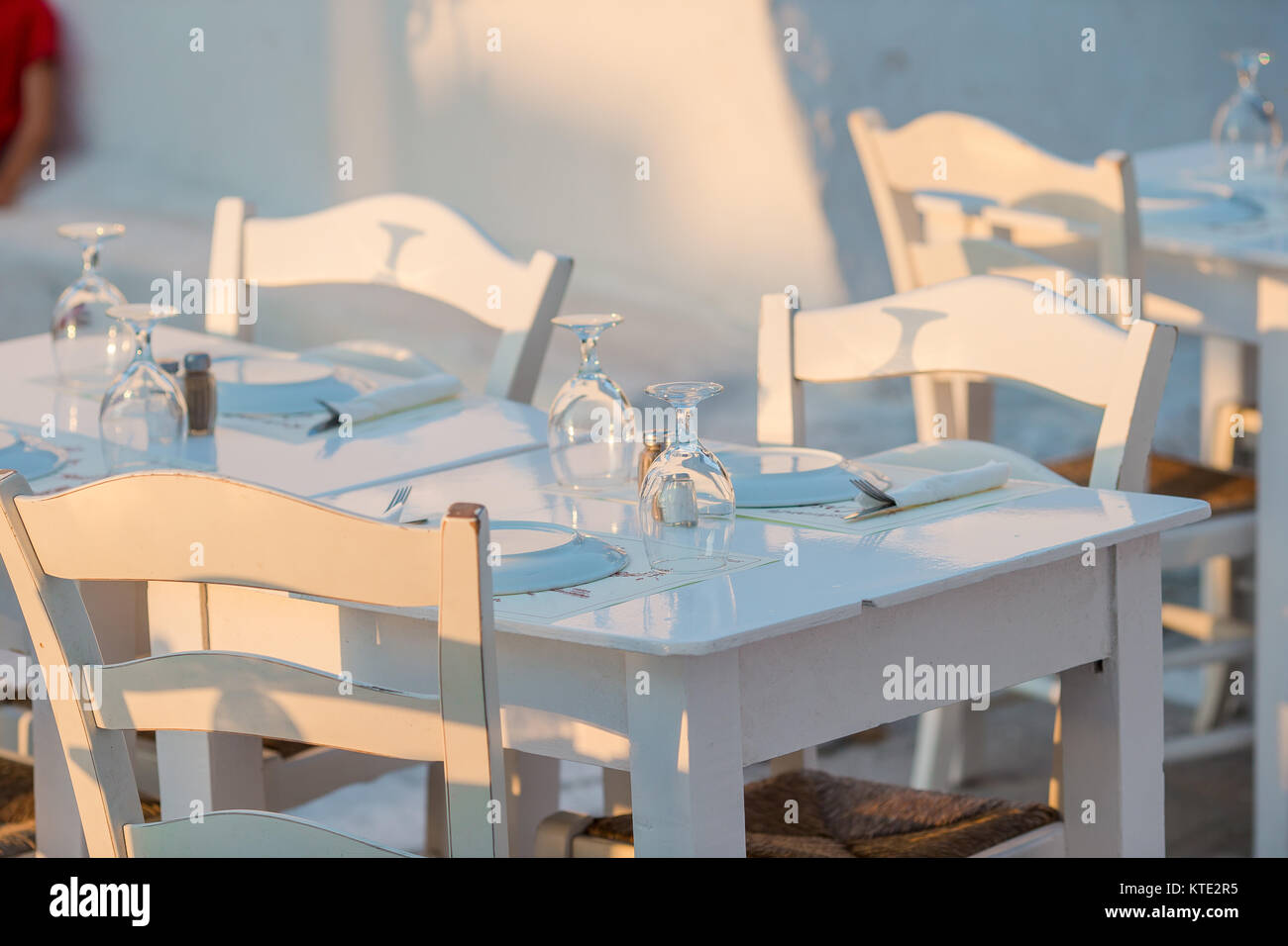 Outdoor cafe on a street of typical greek traditional village in Greece ...