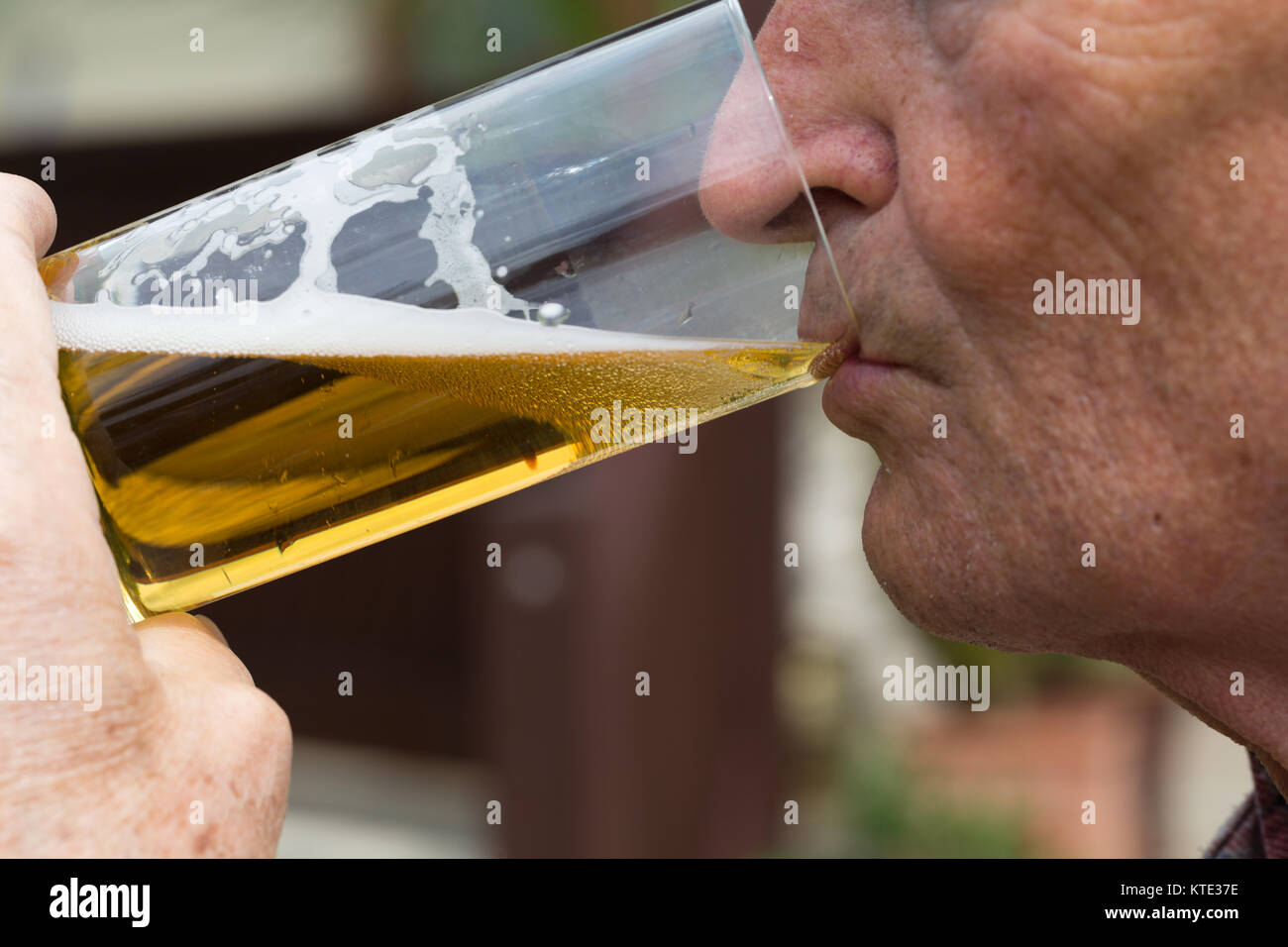 Mature man drinks beer. Best is the first draught Stock Photo - Alamy