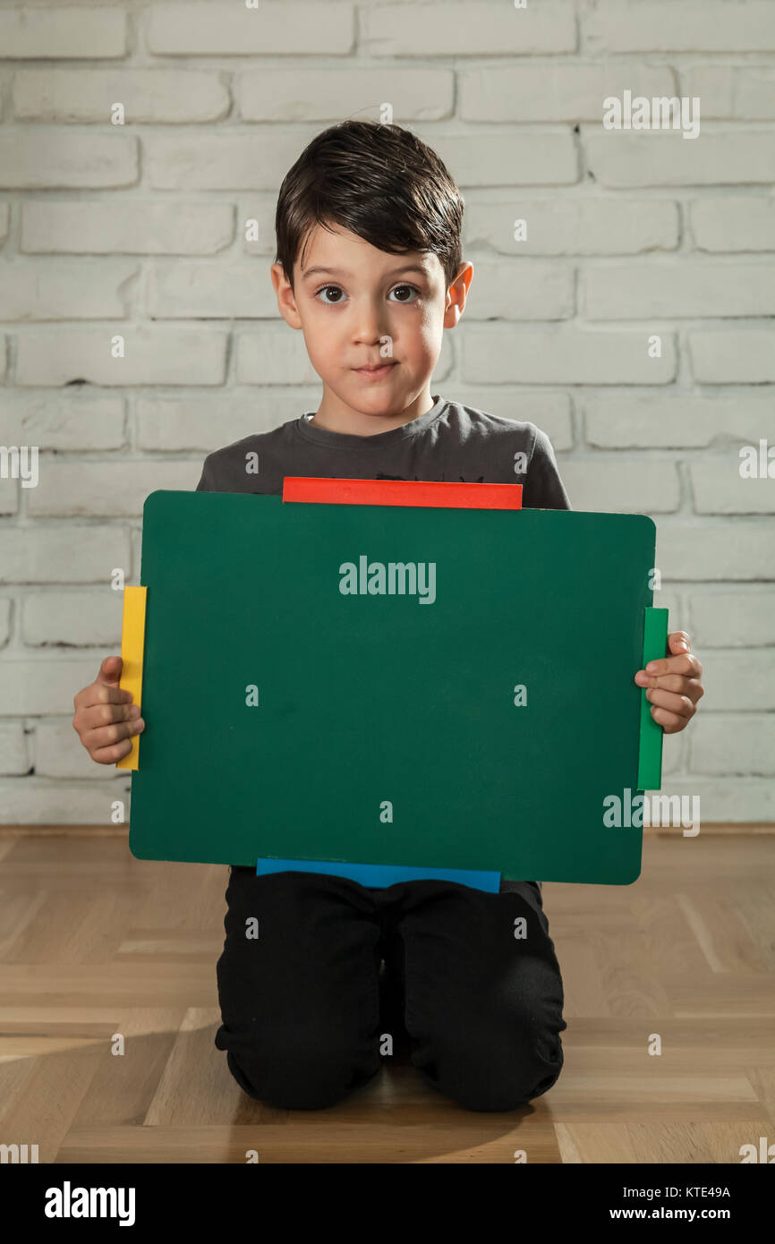 portrait of a cute kid holding a chalkboard Stock Photo - Alamy