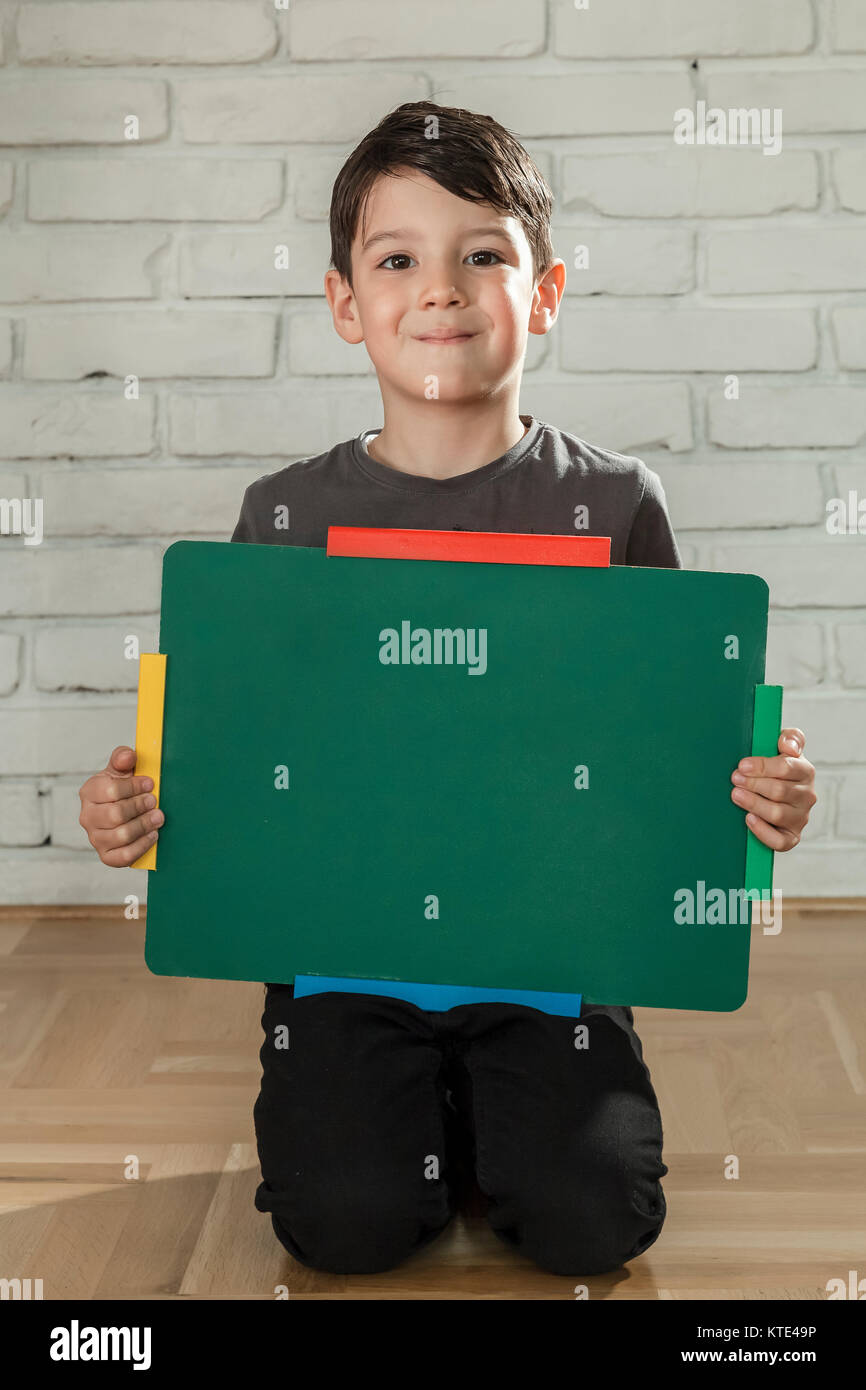 portrait of a cute kid holding a chalkboard Stock Photo - Alamy