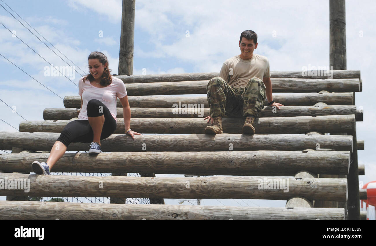 Bashalei and Nicholas Dold tackle the "weaver" obstacle as they run the ...