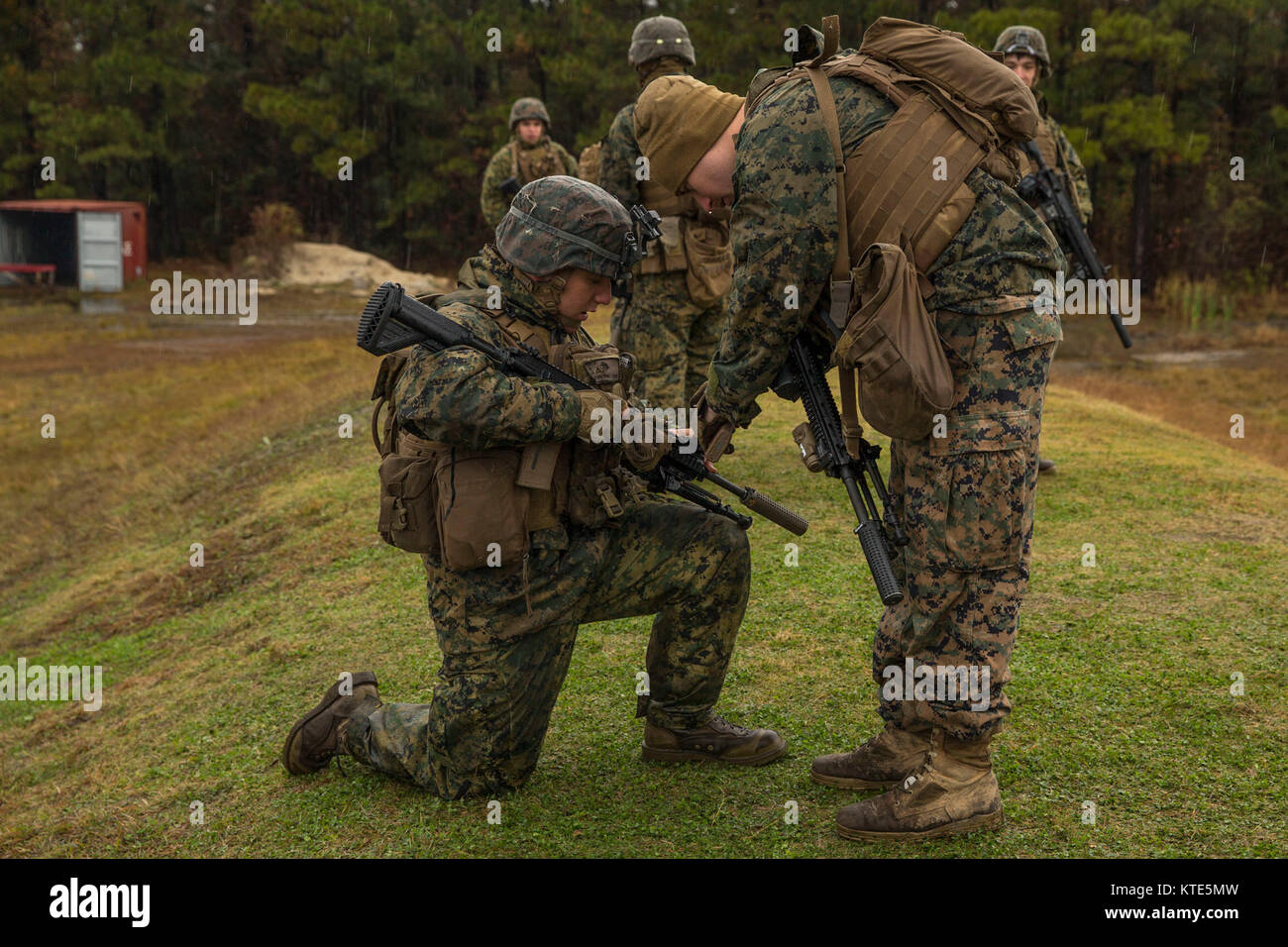 U.S. Marines with 3rd Battalion 8th Marine Regiment fire the M27 ...