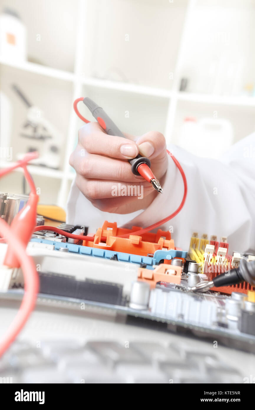 Technological background with closeup on tester checking motherboard ...