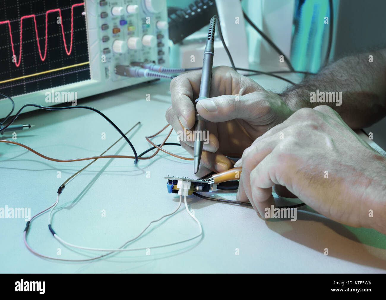 Tech tests electronic equipment in service center Stock Photo - Alamy