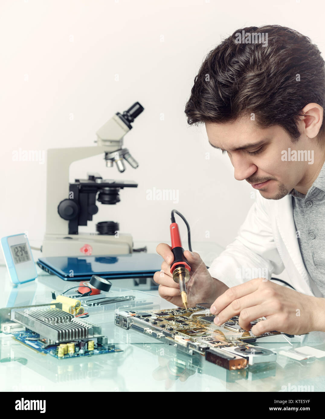 Male tech repairs electronic equipment hi-res stock photography and ...