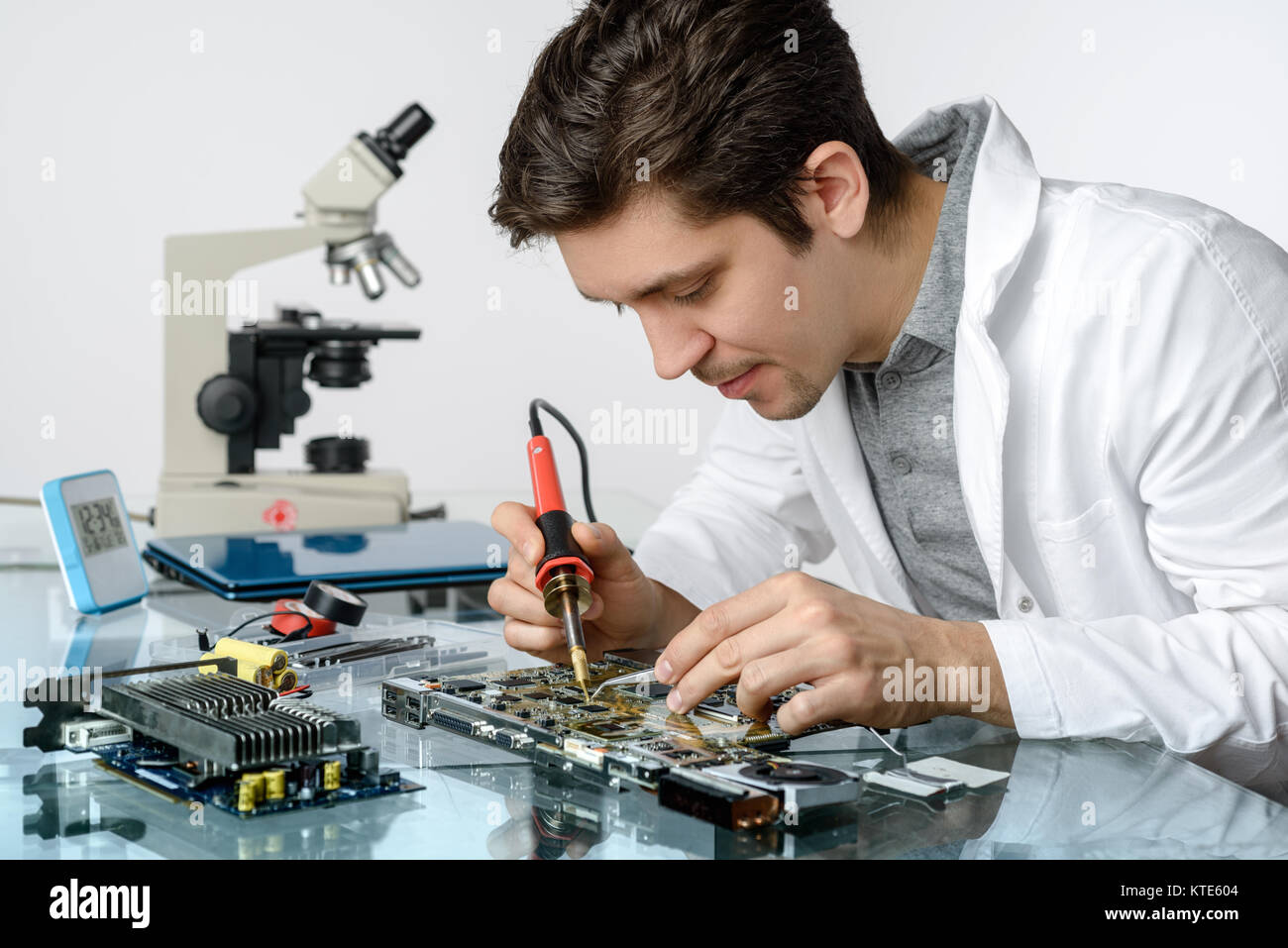 Male tech repairs electronic equipment hi-res stock photography and ...