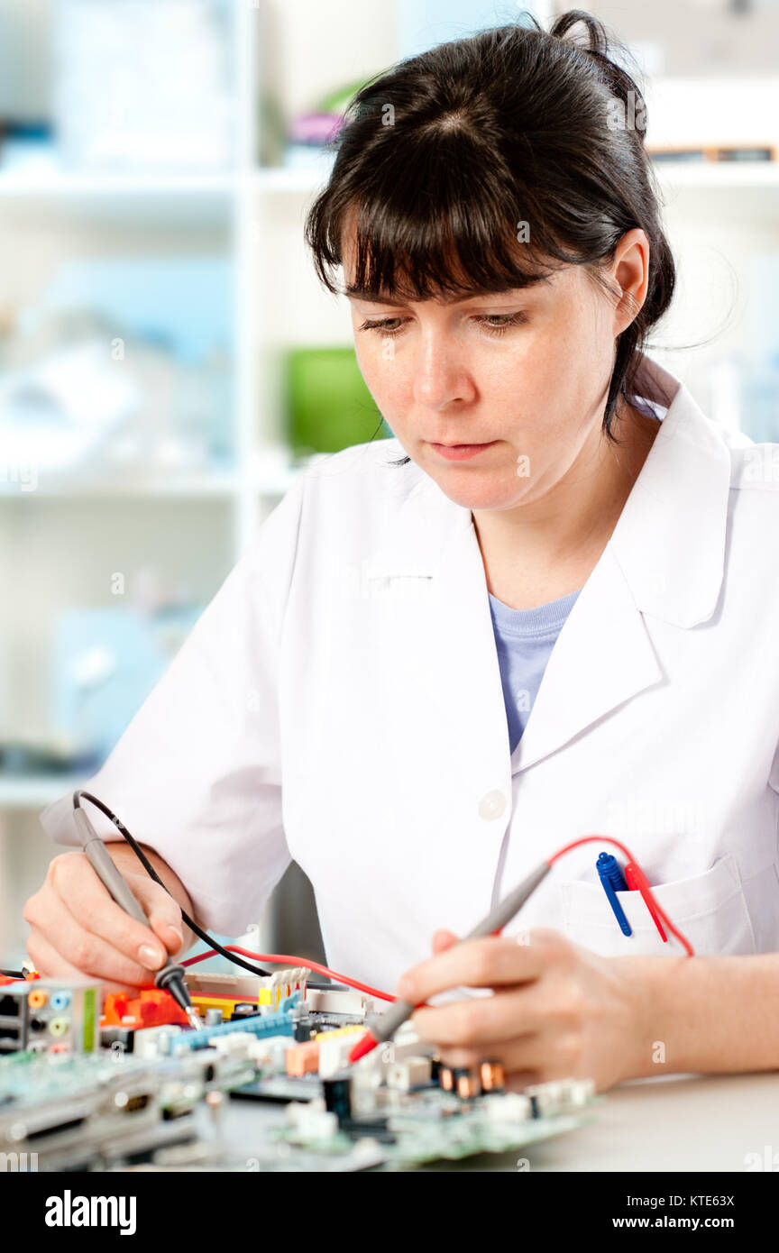 Electronics repair tech fixes surcuit board Stock Photo - Alamy
