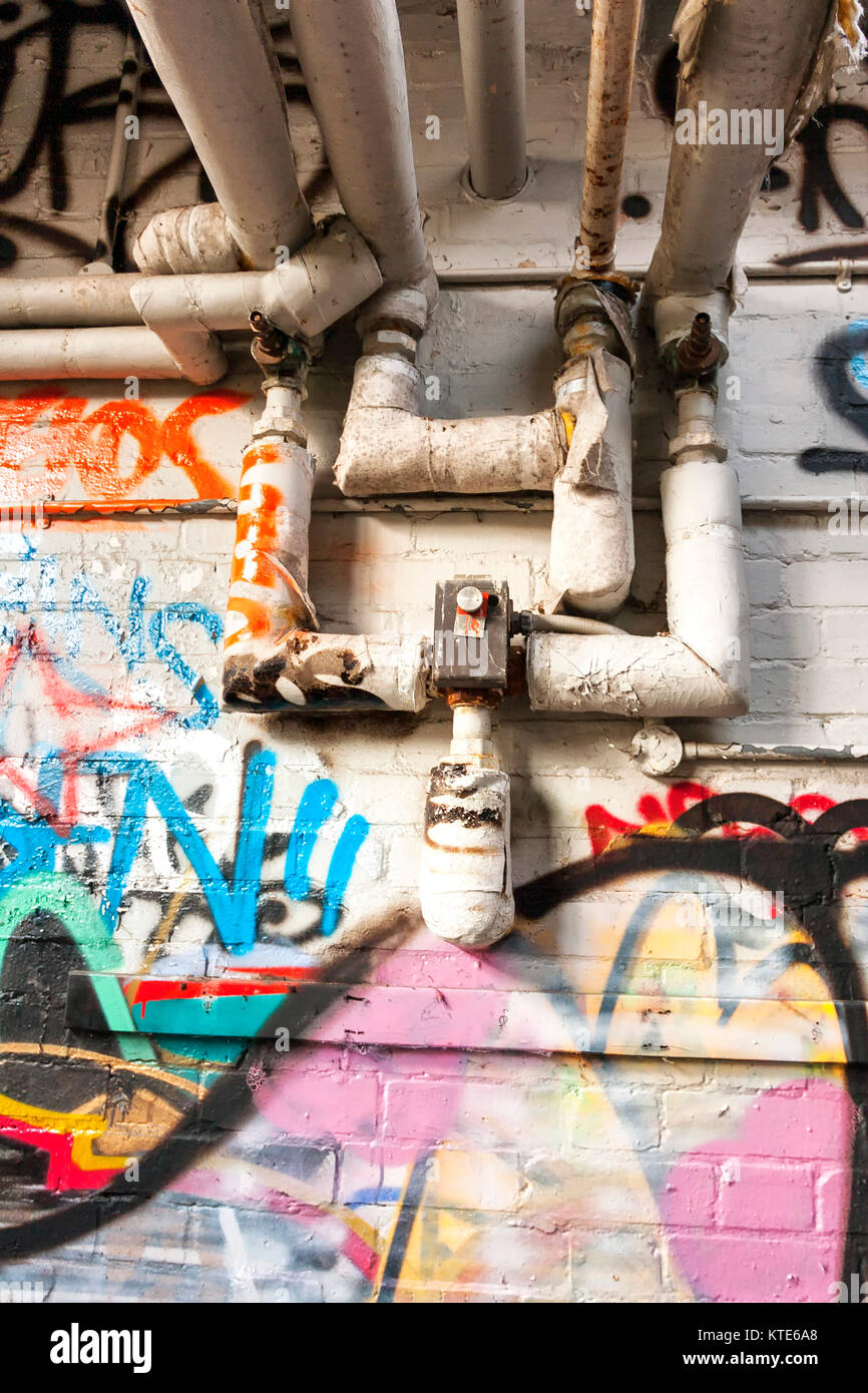 Graffiti on heating heating pipes Stock Photo - Alamy
