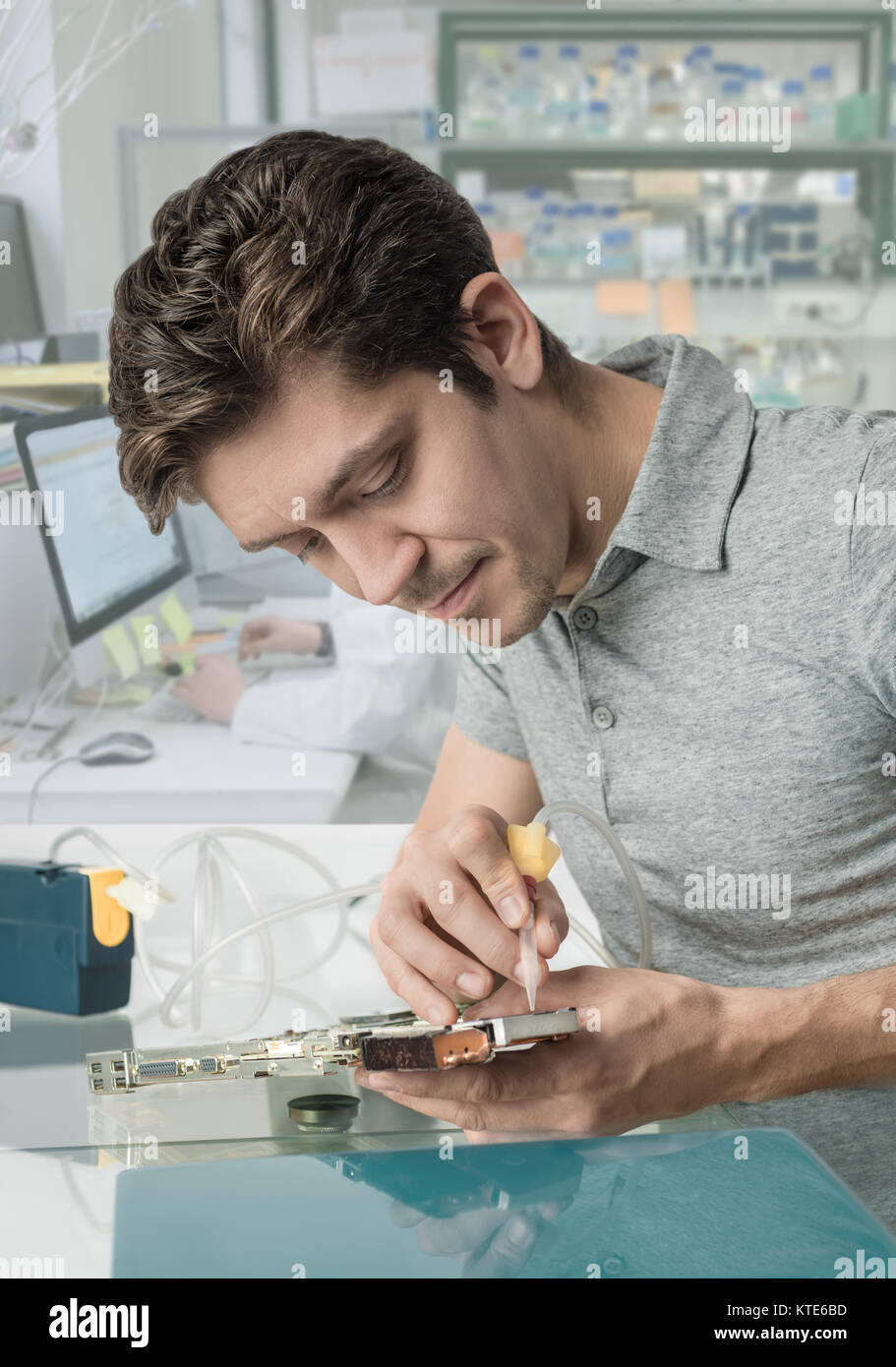 Young male tech with curly brown hair works in in research facility ...
