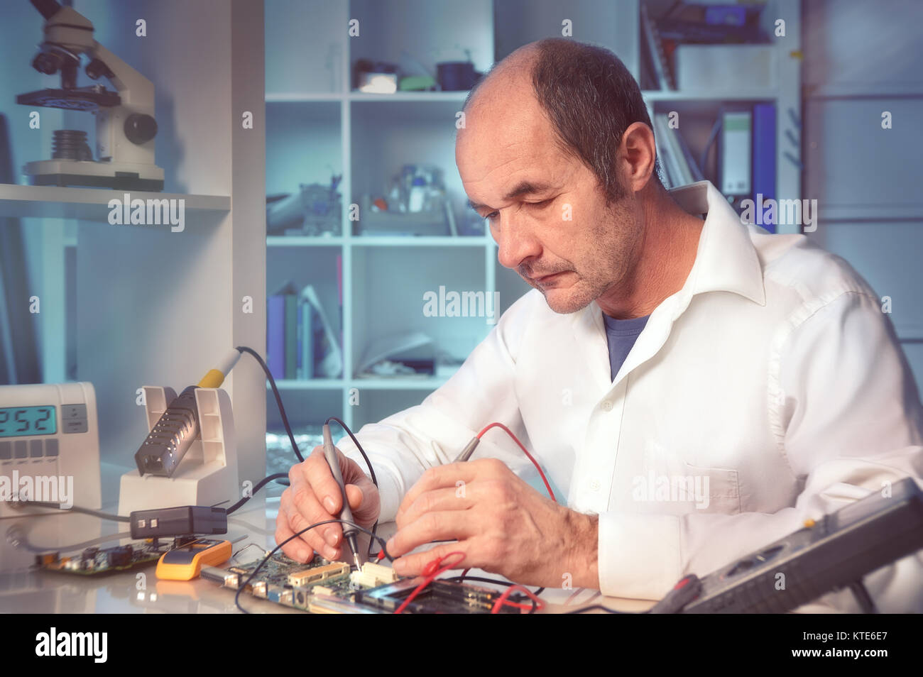 Senior male tech tests electronic equipment, toned image Stock Photo ...