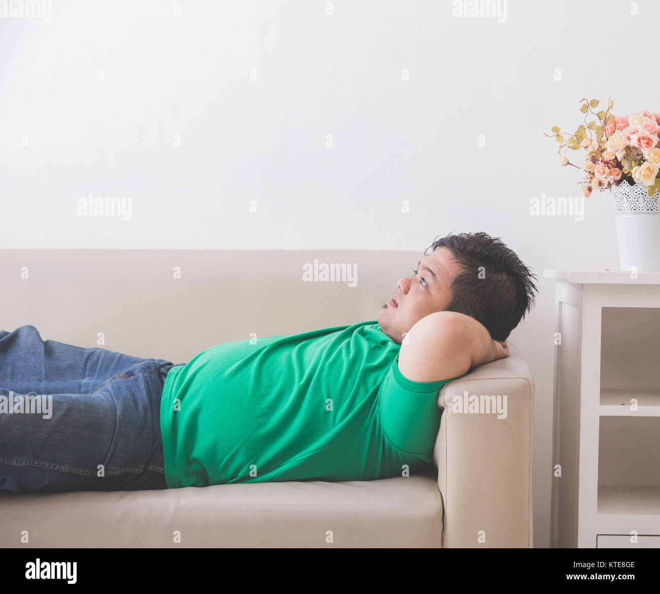 Fat man laying on couch hi-res stock photography and images - Alamy