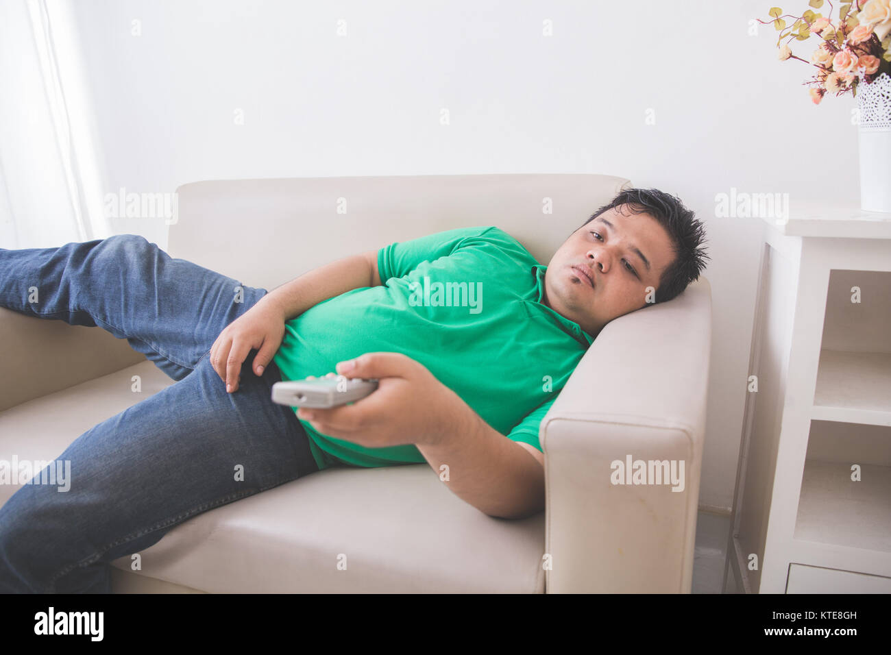 Obese watching tv hi-res stock photography and images - Alamy