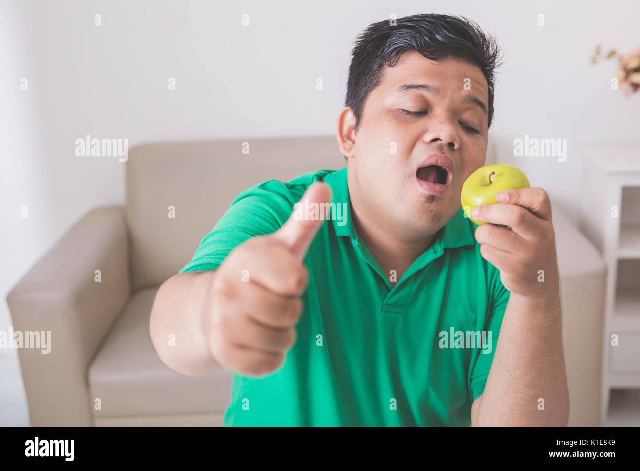 obese man trying to eat healthy fresh food Stock Photo - Alamy