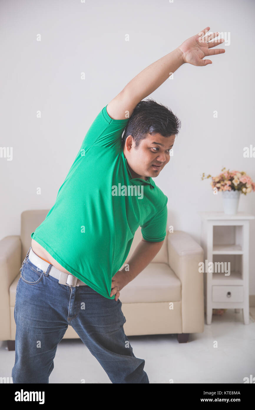 overweight man doing some exercise at home Stock Photo - Alamy