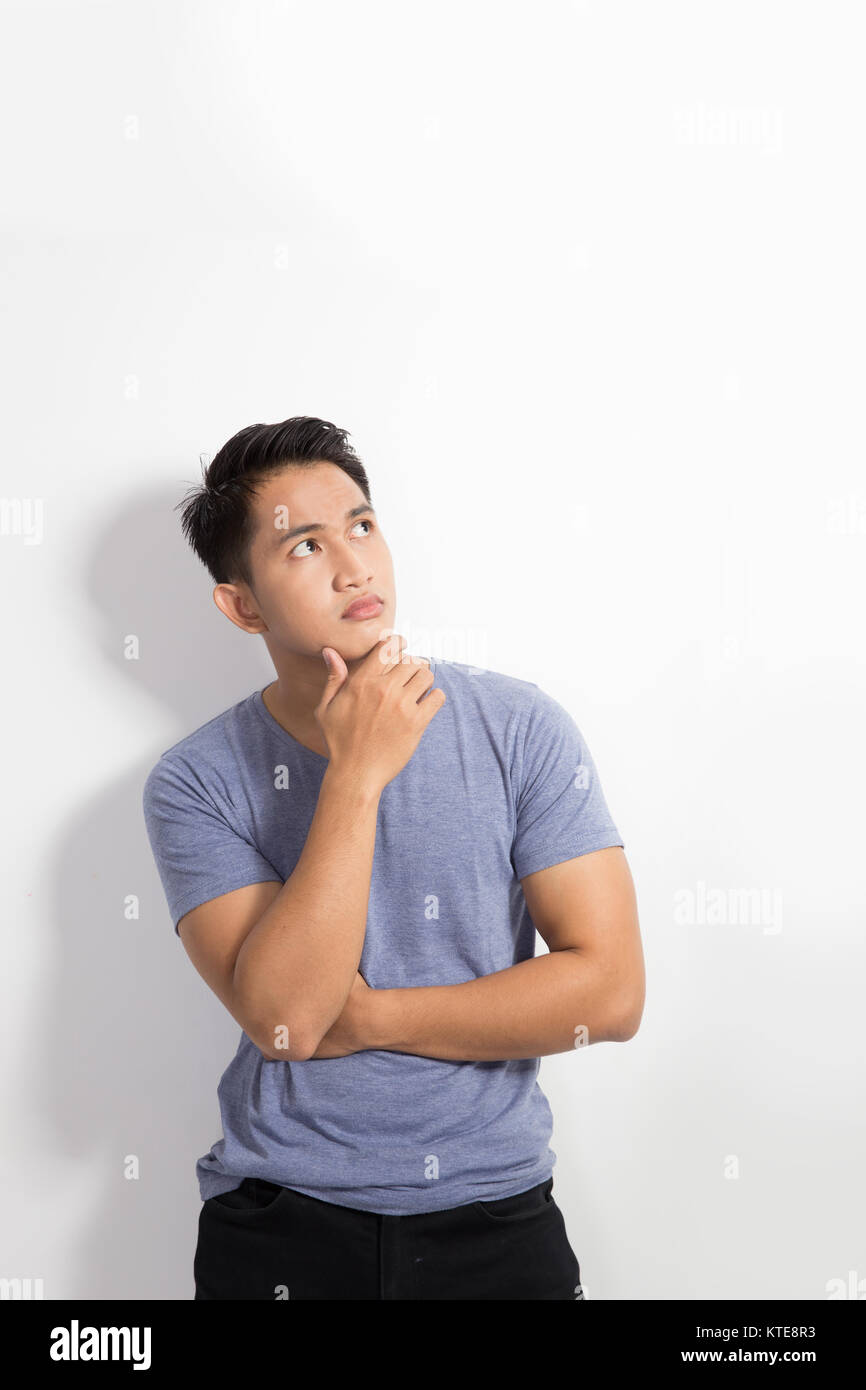 Young asian man thinking looking up isolated Stock Photo - Alamy