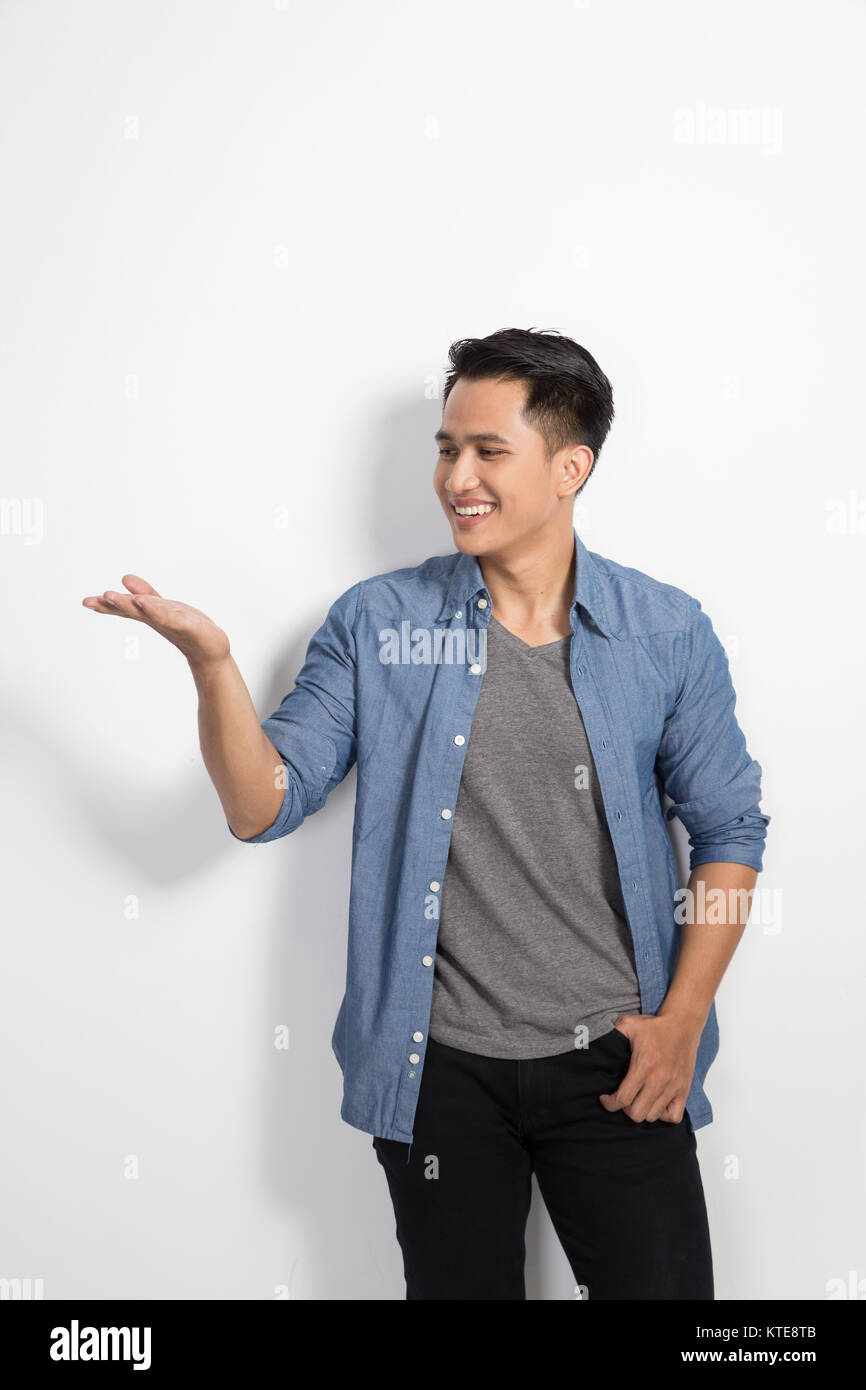 Young happy asian man smile to the camera, prensenting hand gest Stock ...