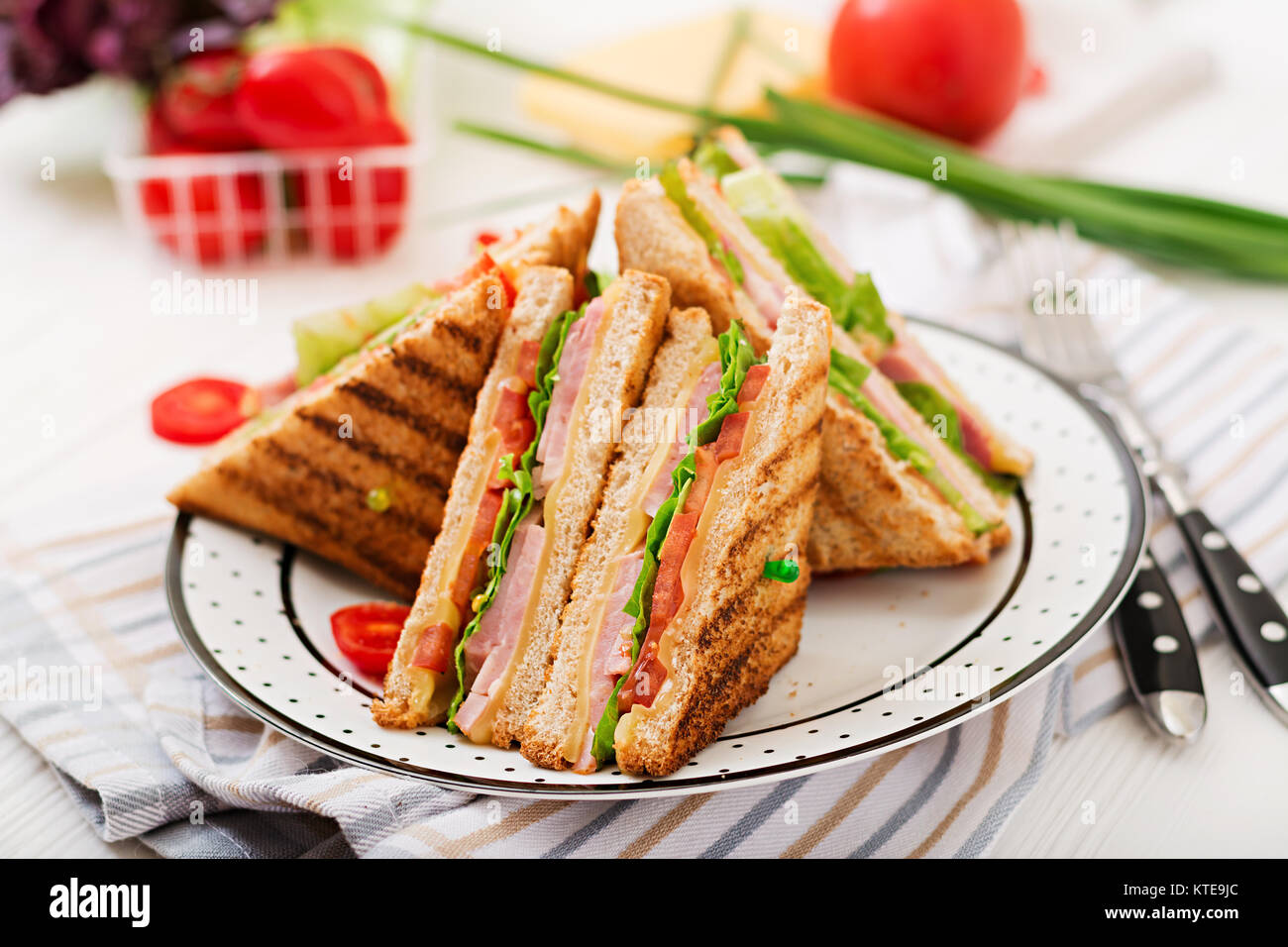 Club sandwich - panini with ham, cheese, tomato and herbs. Top view ...