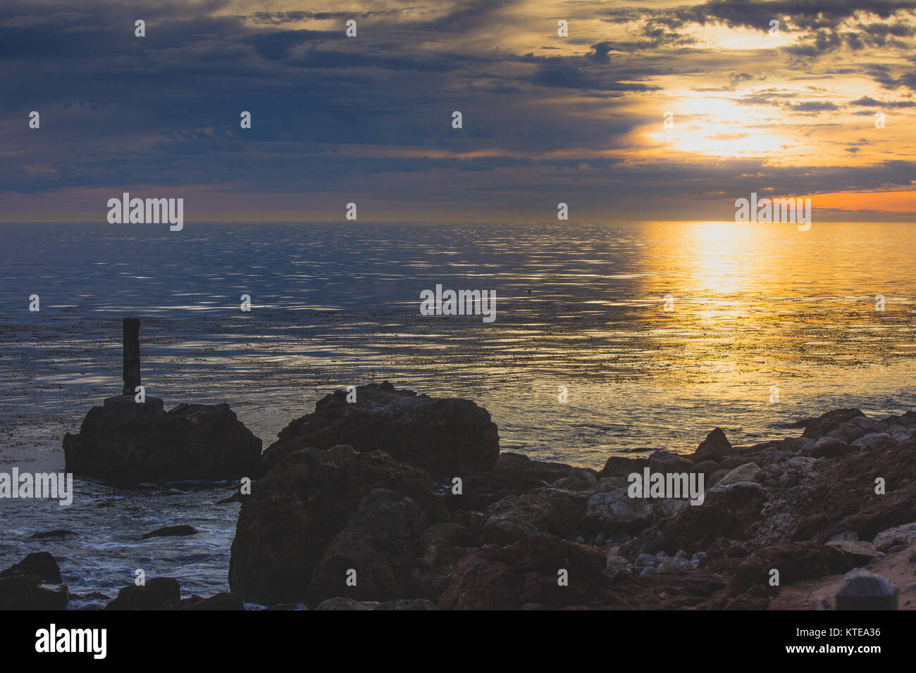 Breathtaking coastal view of a sunset with clouds in the sky from ...