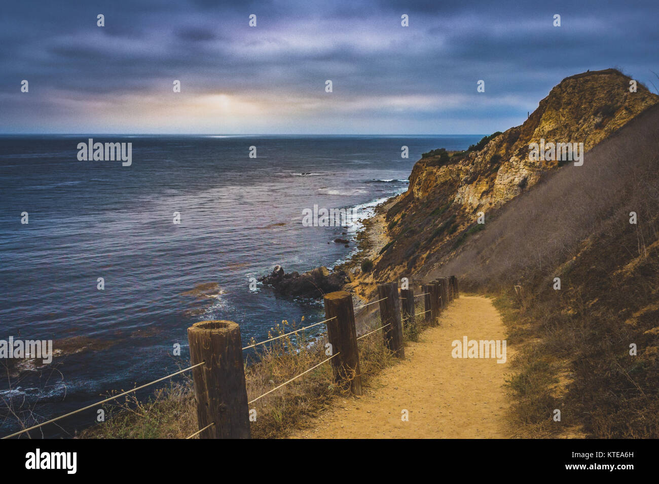 Coastal hiking trail cascading down the steep cliffs of Pelican Cove ...