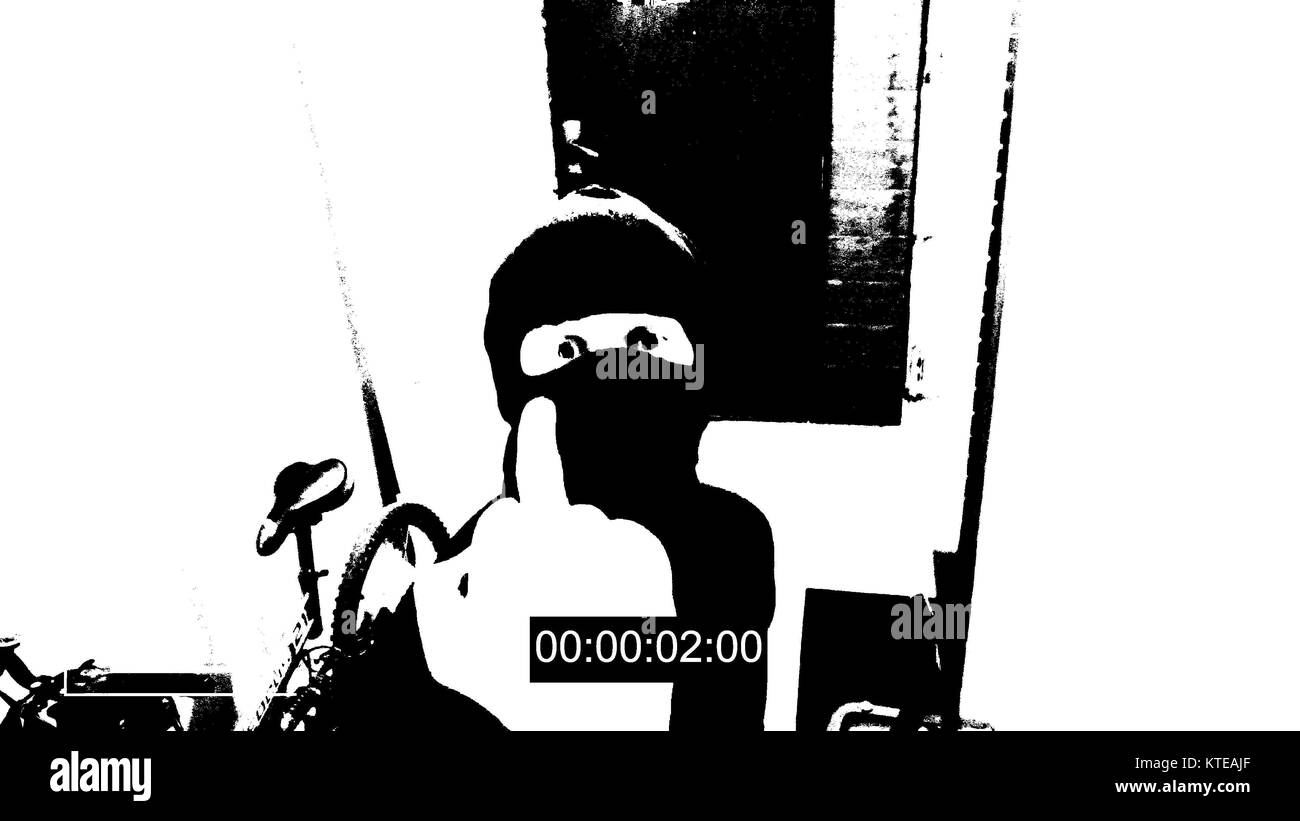 Robber shows the middle finger in the camera threshold effect Stock ...