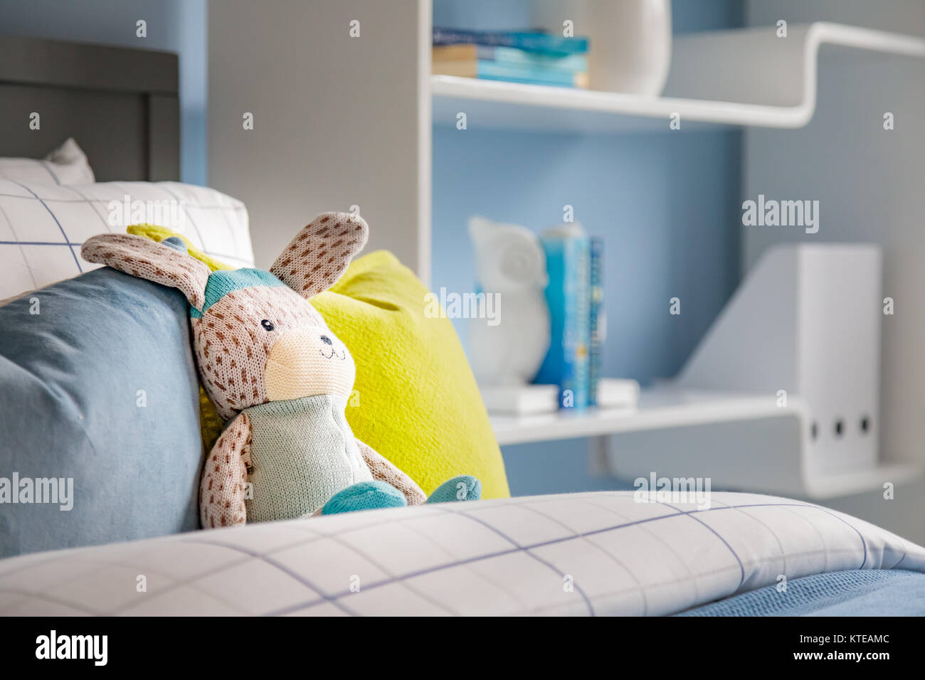 Rabbit soft toy on child’s bed interior UK Stock Photo - Alamy