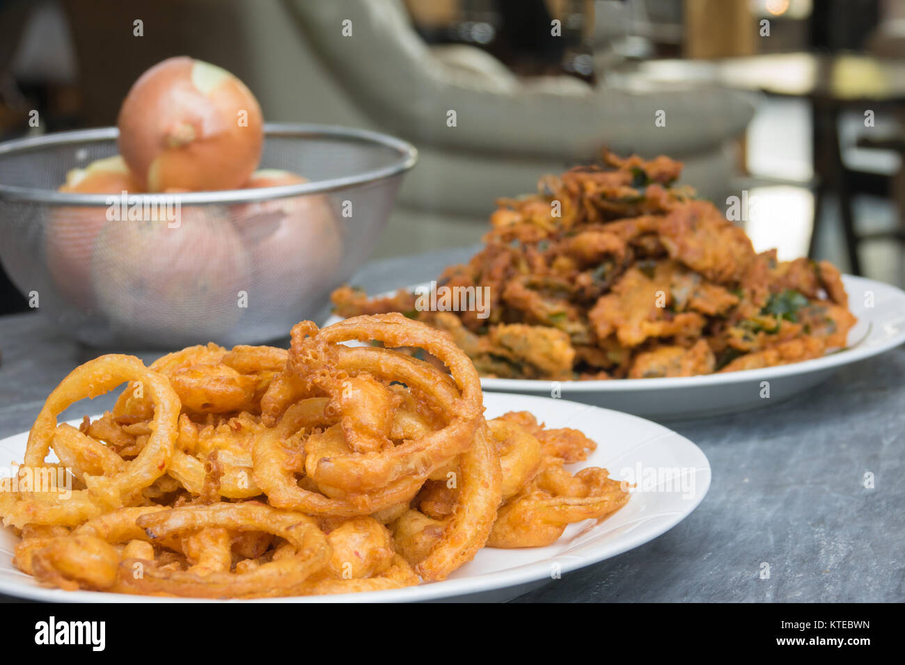 Onion ring in white dish with fried various vegetables on table Stock ...