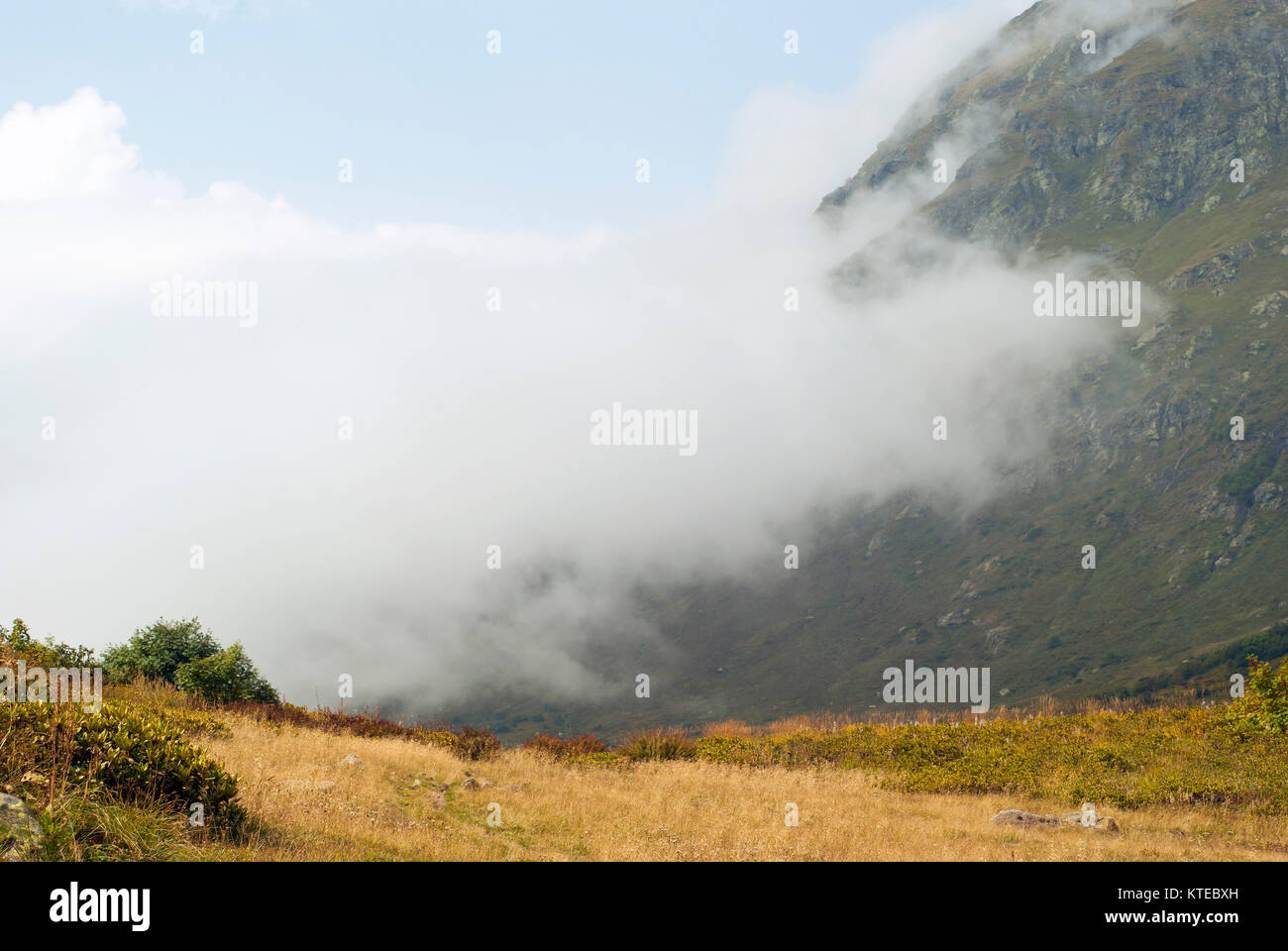 highlands landscape - a cloud creeping on the autumnal alpine meadow ...