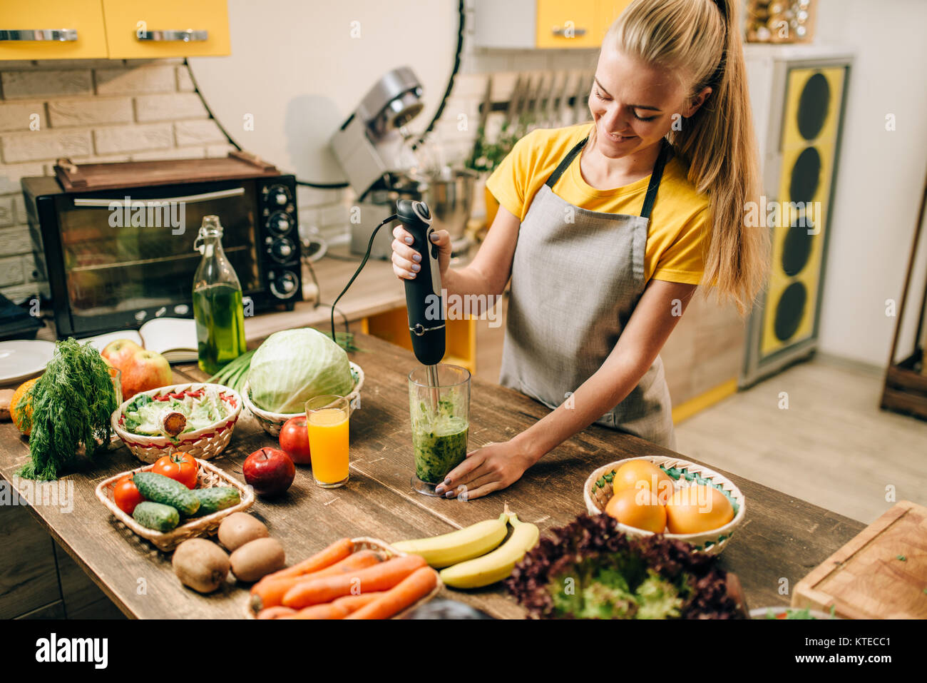 Female person cooking on the kitchen, mixing healthy organic food in a ...