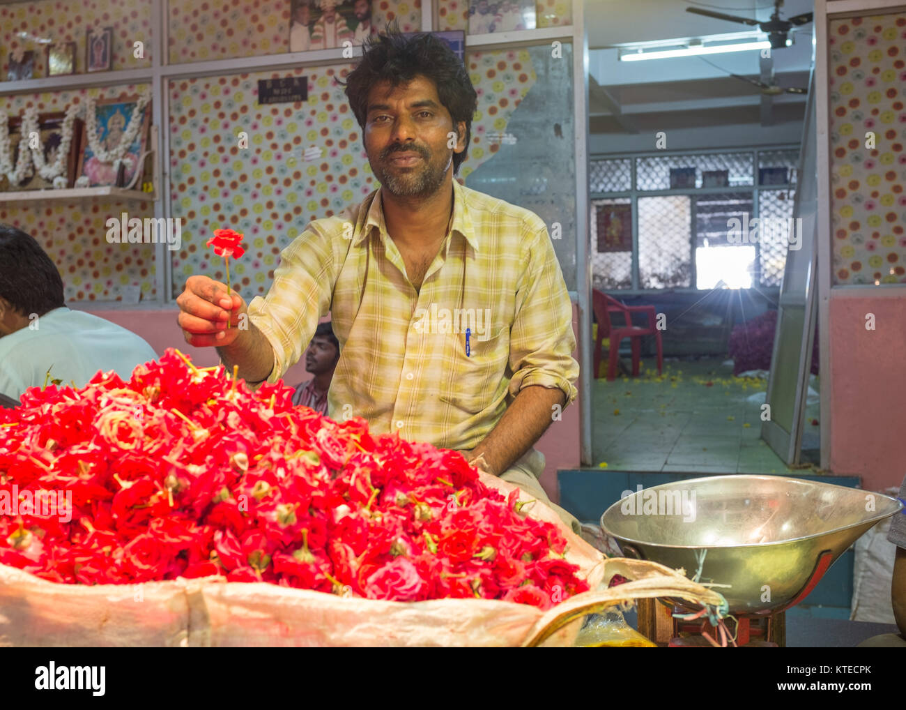 Man selling red flowers, Krishnarajendra market, Bangalore, Karnataka ...