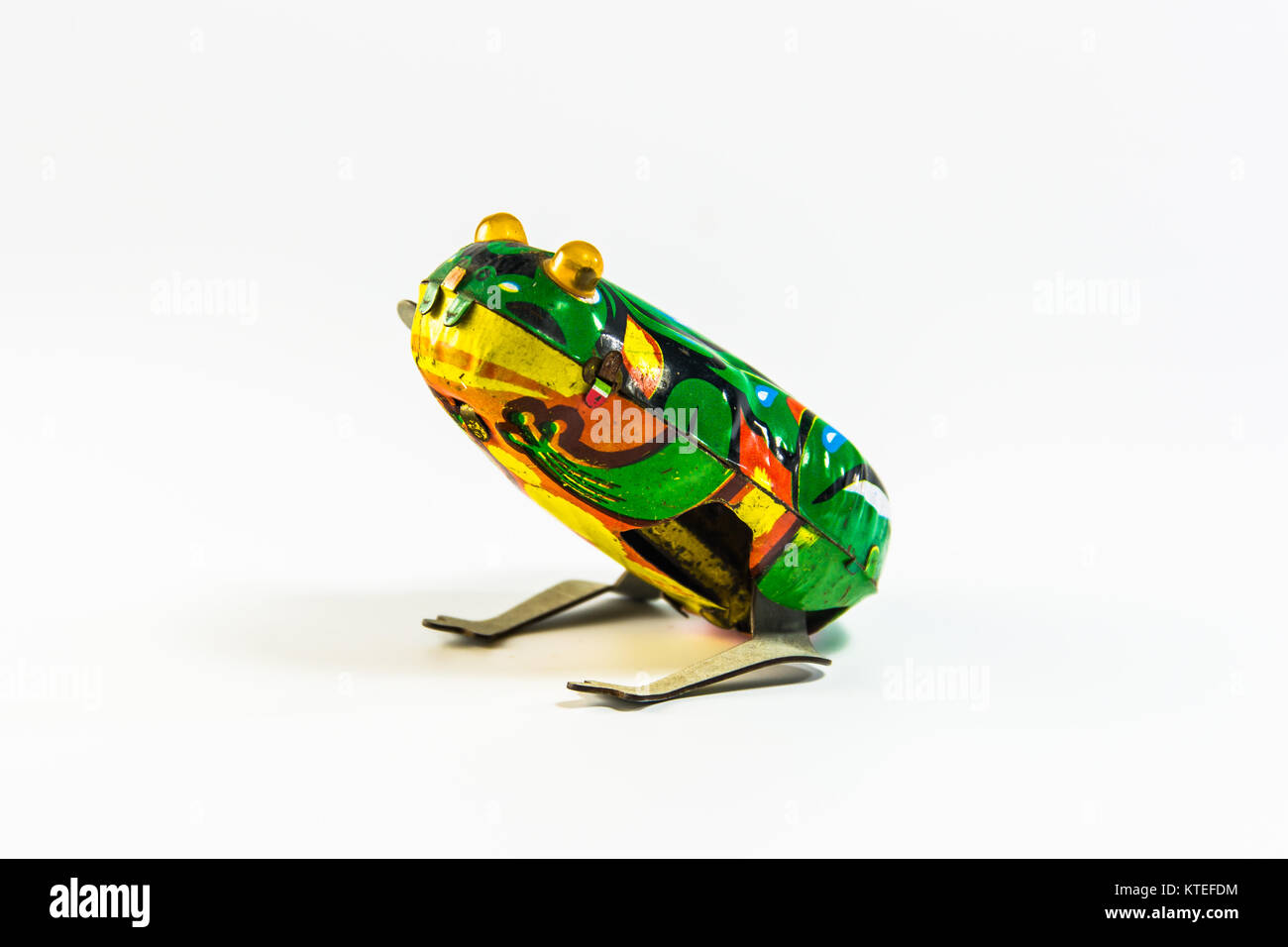 antique tin windup frog on a white background Stock Photo - Alamy