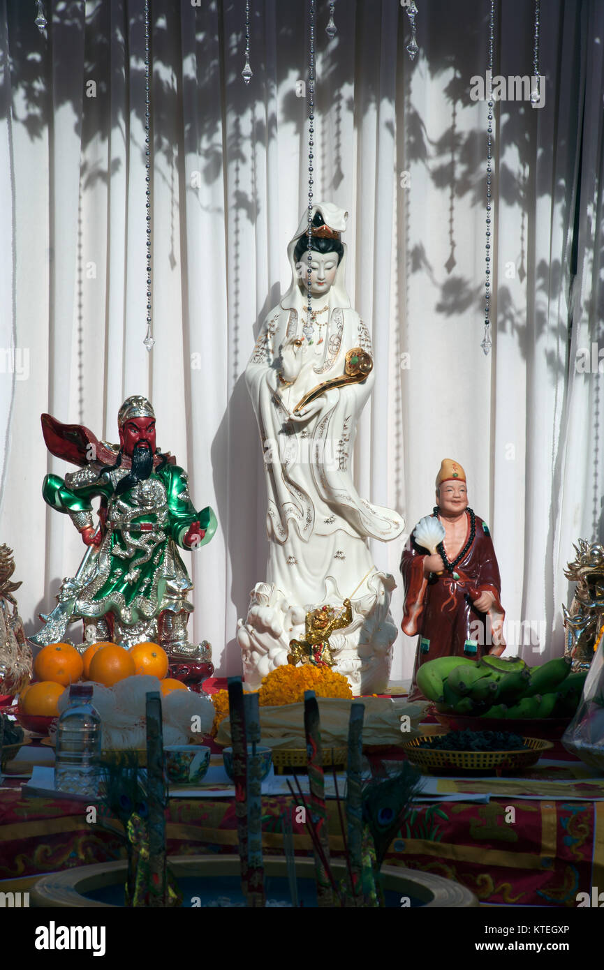 Statue of Chinese God Guan Yin on God altar table on the street of ...