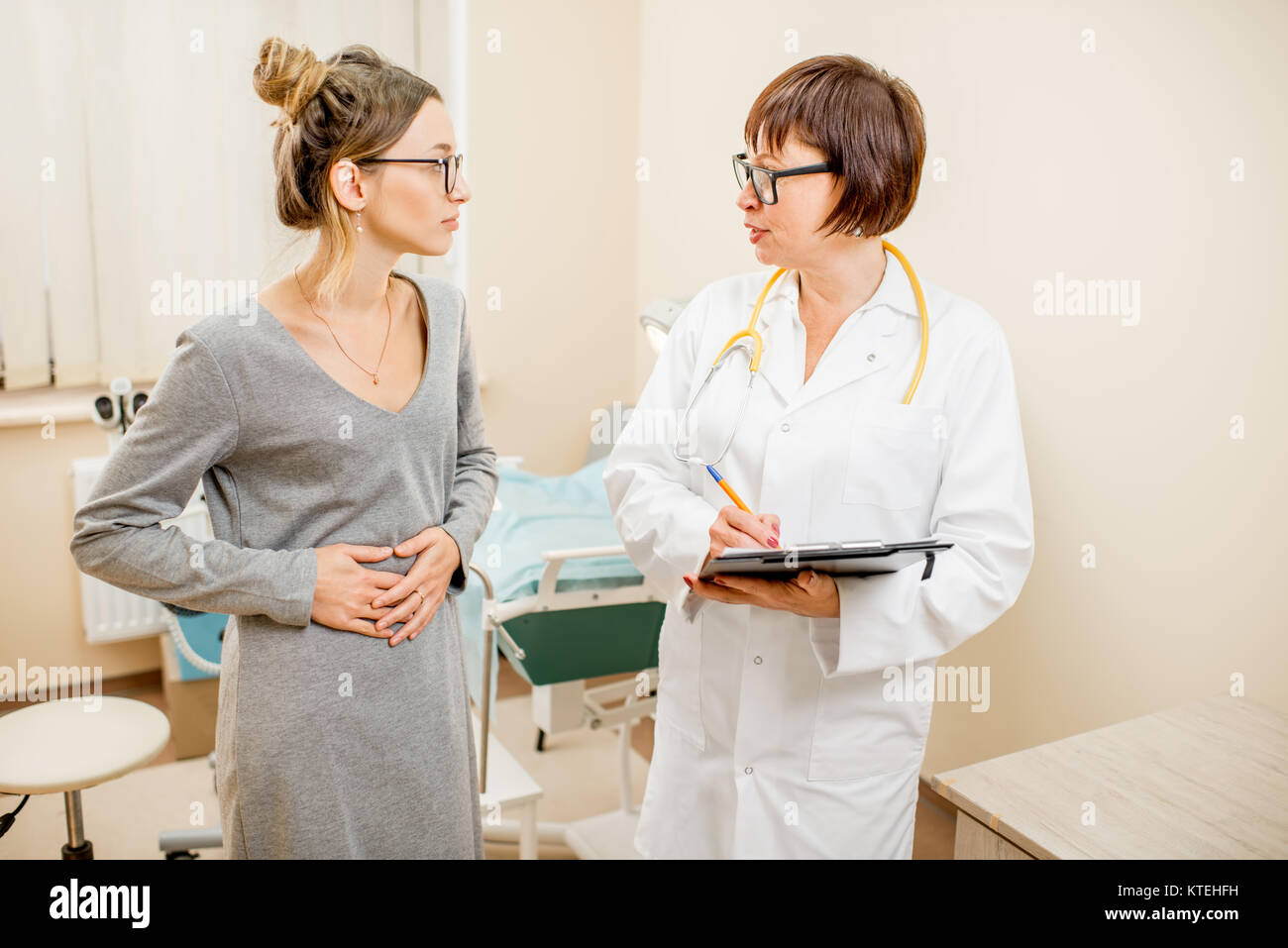 Young woman patient with a senior gynecologist during the consultation ...