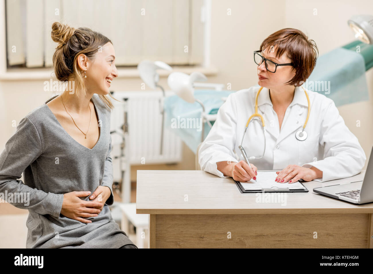 Young woman patient with a senior gynecologist during the consultation ...