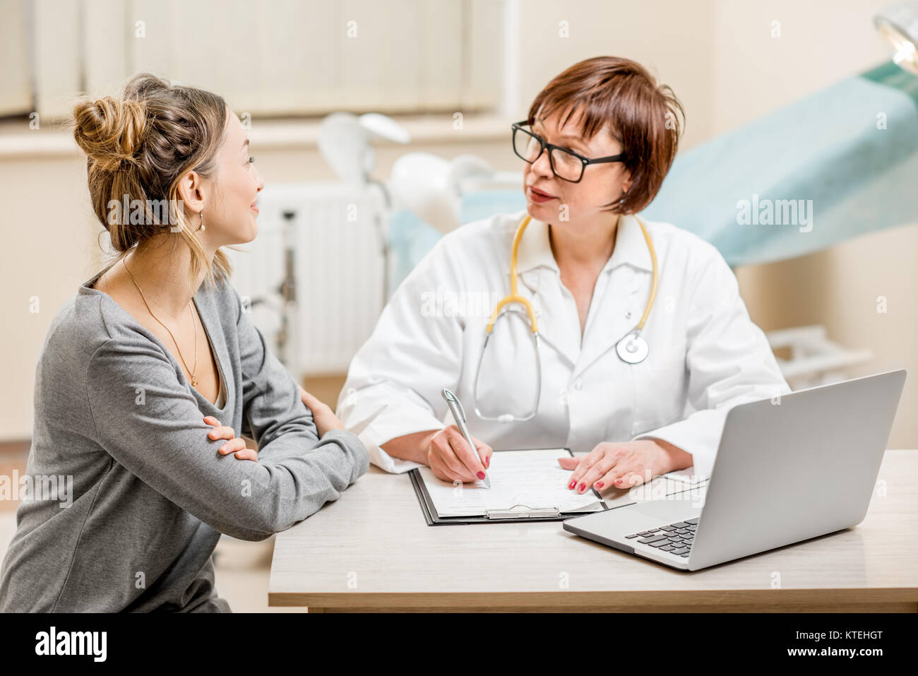 Young woman patient with a senior gynecologist during the consultation ...