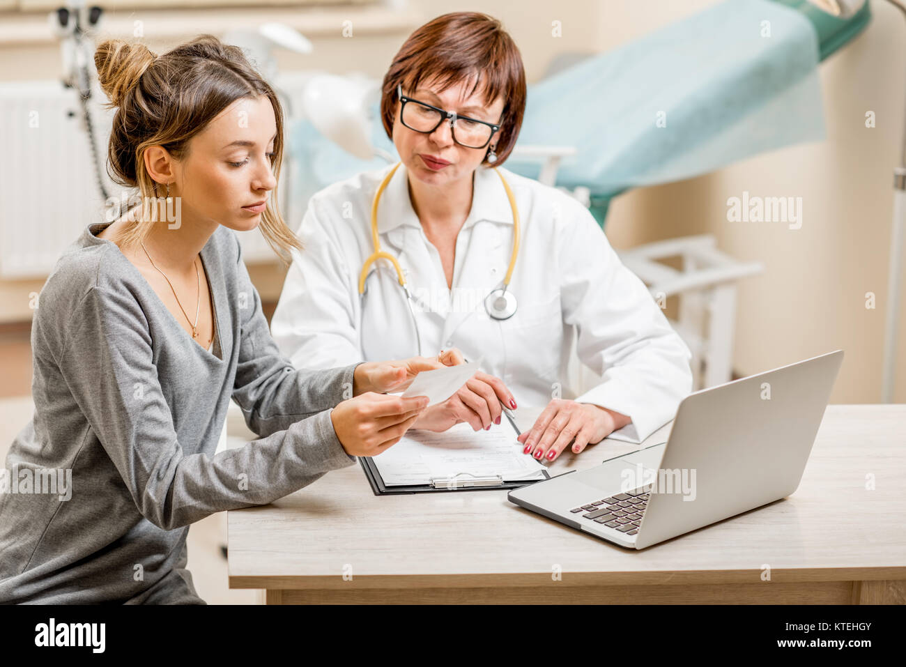 Young woman patient with a senior gynecologist during the consultation ...