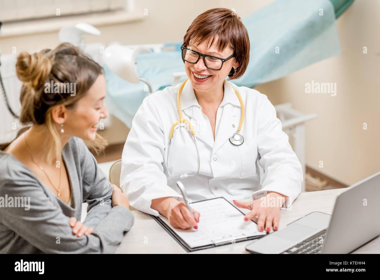 Young woman patient with a senior gynecologist during the consultation ...