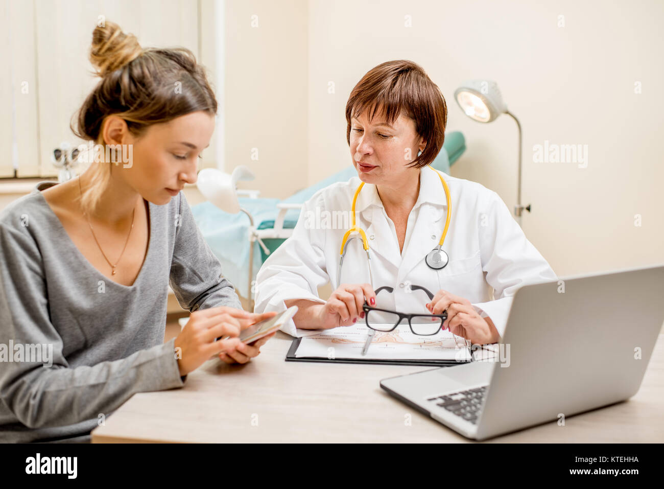 Young woman patient with a senior gynecologist during the consultation ...