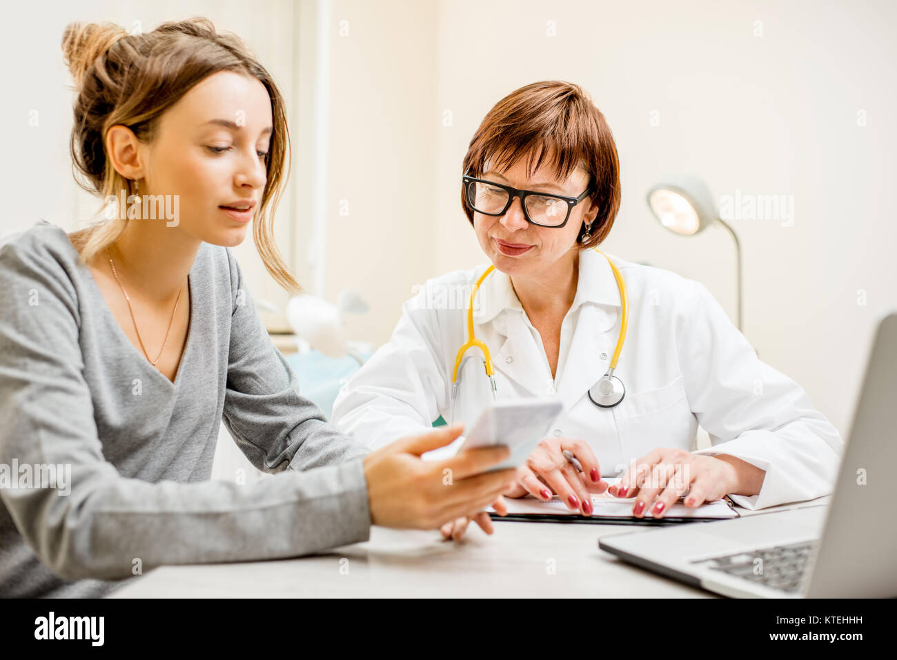 Young woman patient with a senior gynecologist during the consultation ...