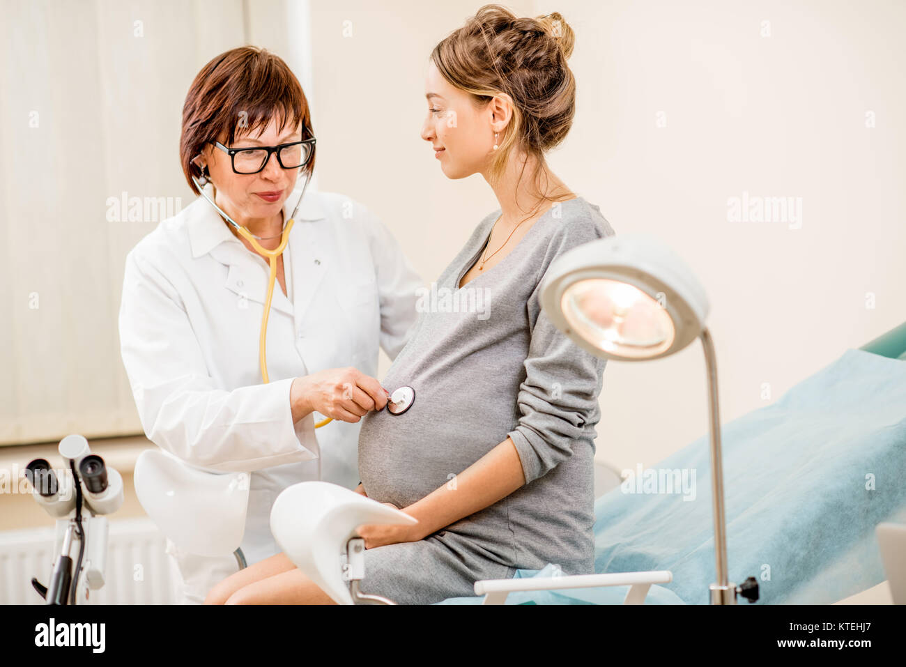 Pregnant woman patient with a senior gynecologist during the ...