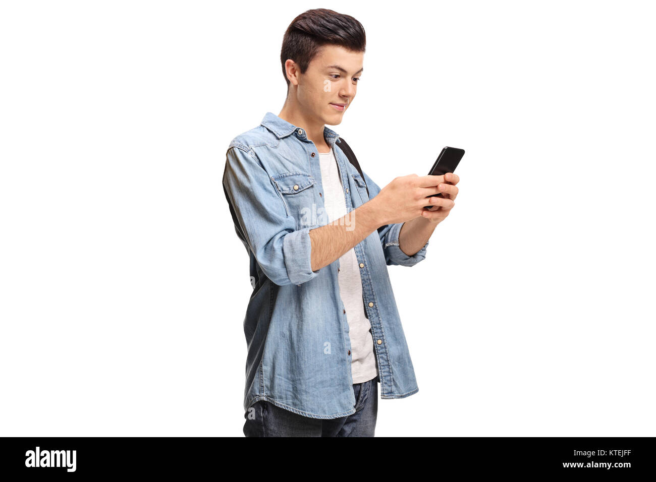 Teenager using a phone isolated on white background Stock Photo - Alamy
