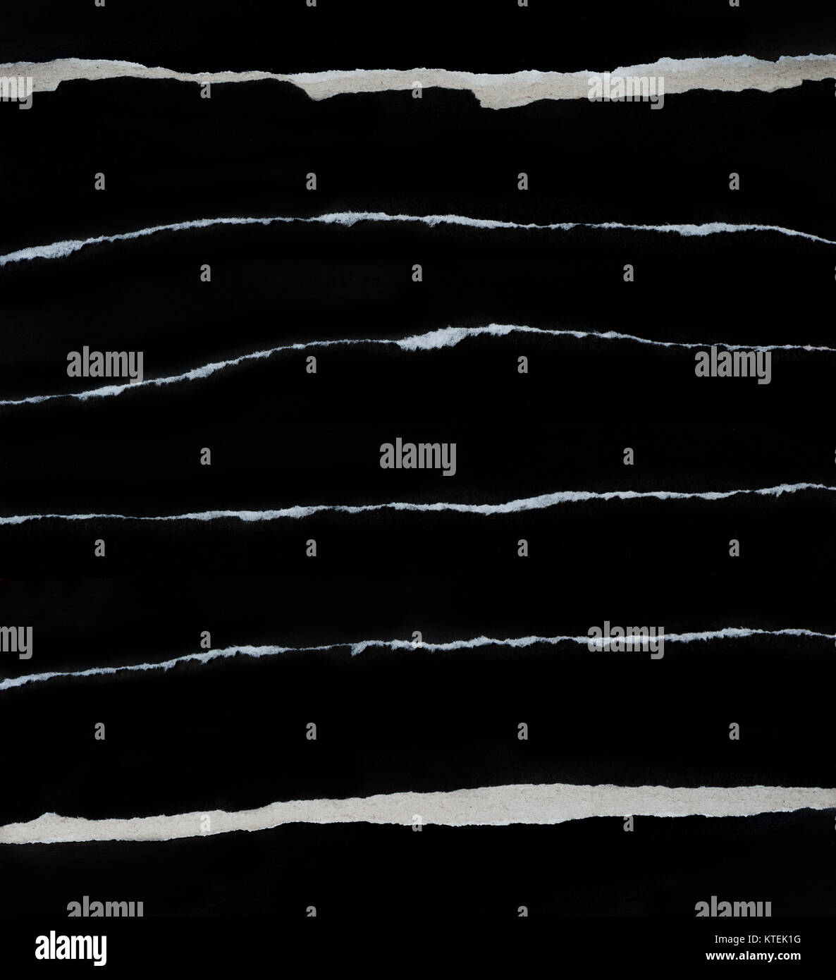 Various teared pieces of paper showing the fibers on dark background ...